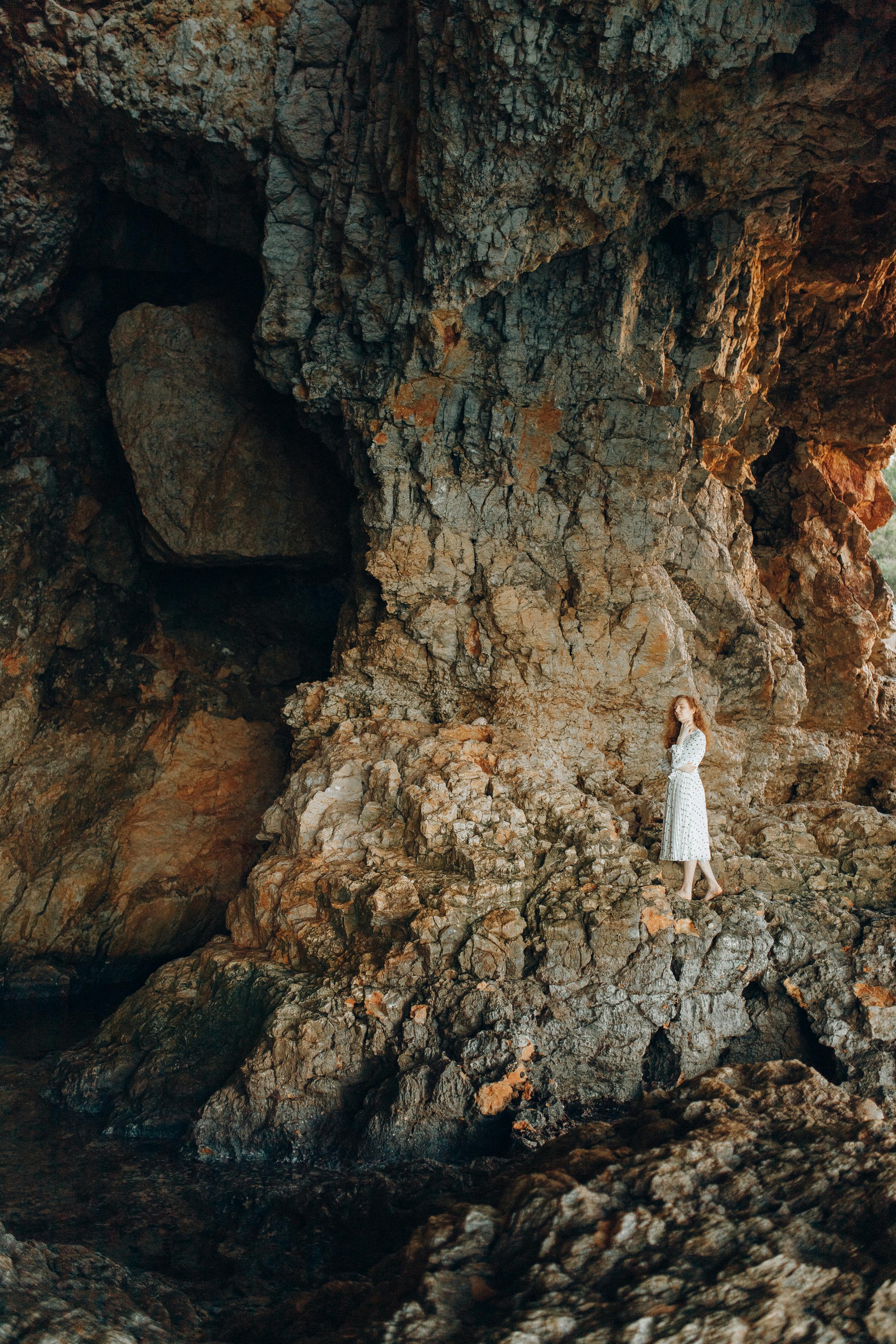 A Woman Standing in a Cave · Free Stock Photo