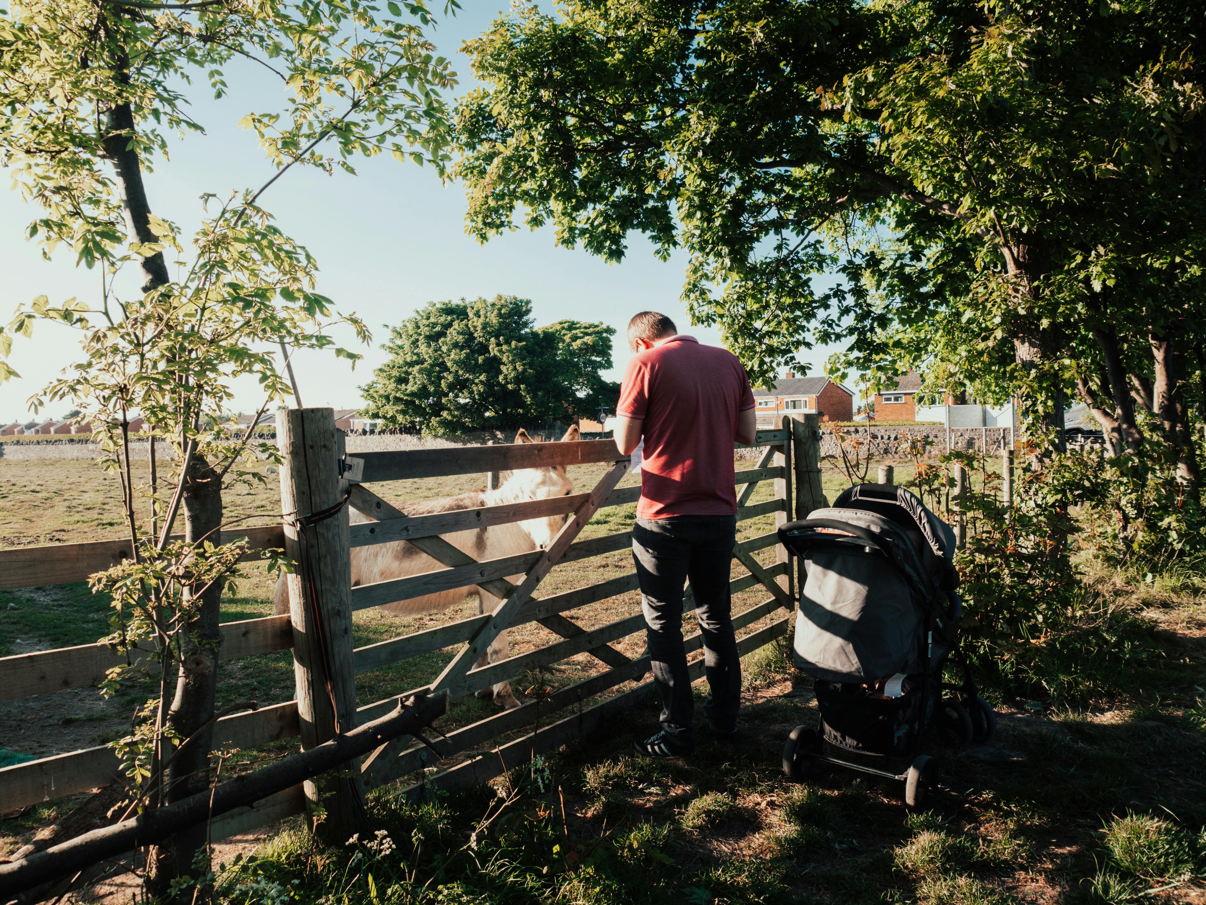 Photo of Man Standing Near Wooden Fence · Free Stock Photo