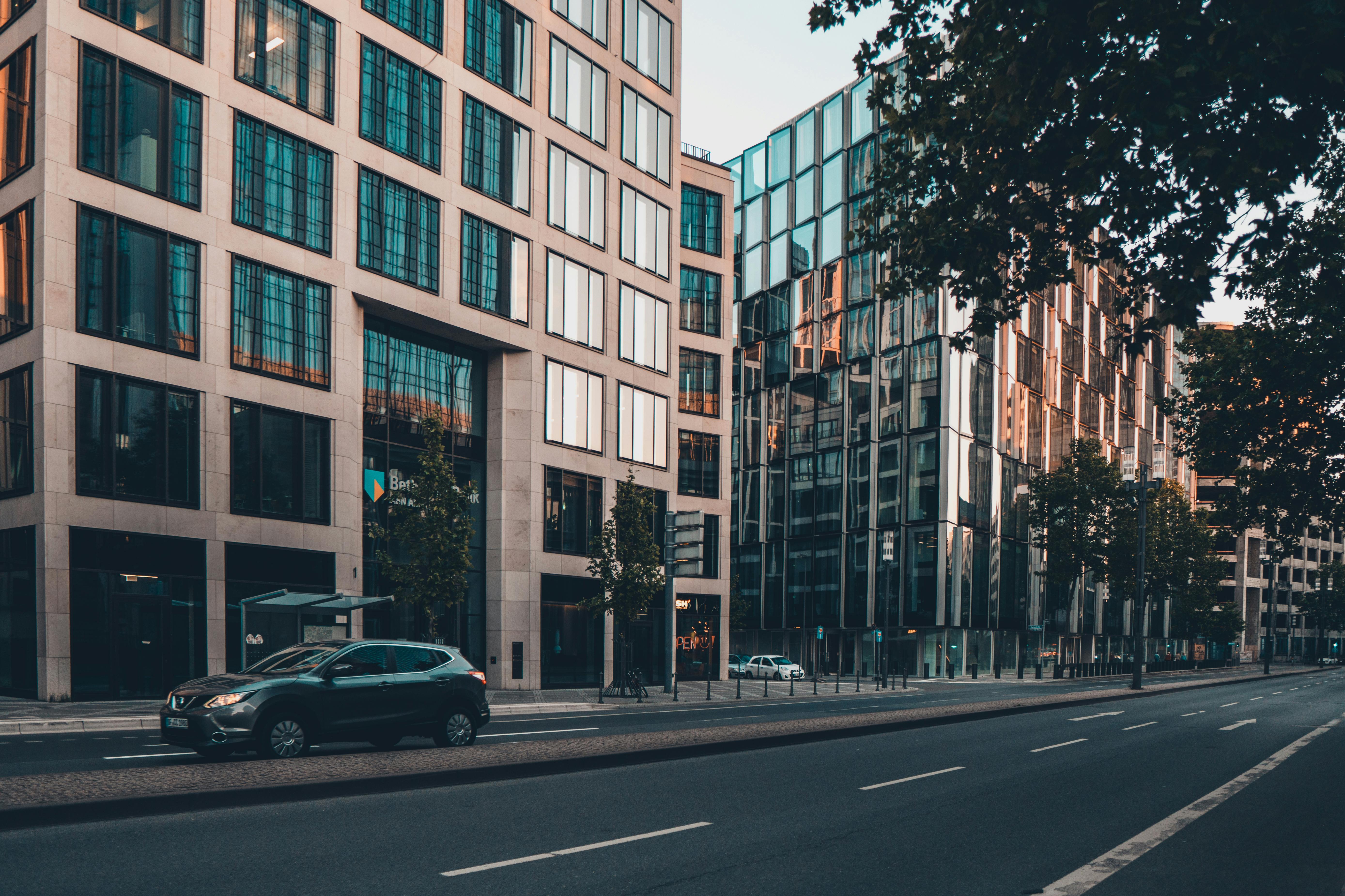 Vehicles Parked Between Buildings · Free Stock Photo