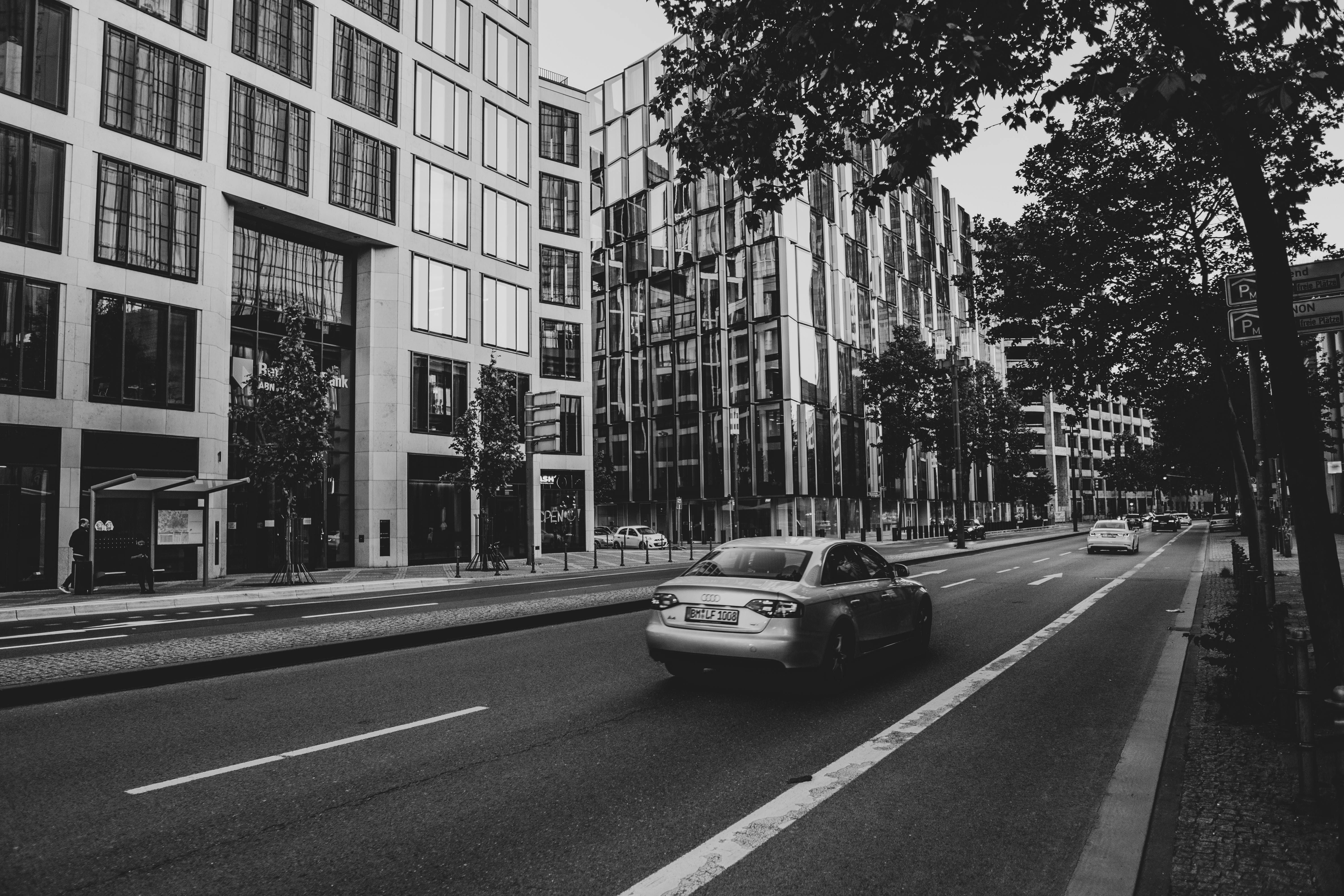 Grayscale Photo of Car on Road · Free Stock Photo