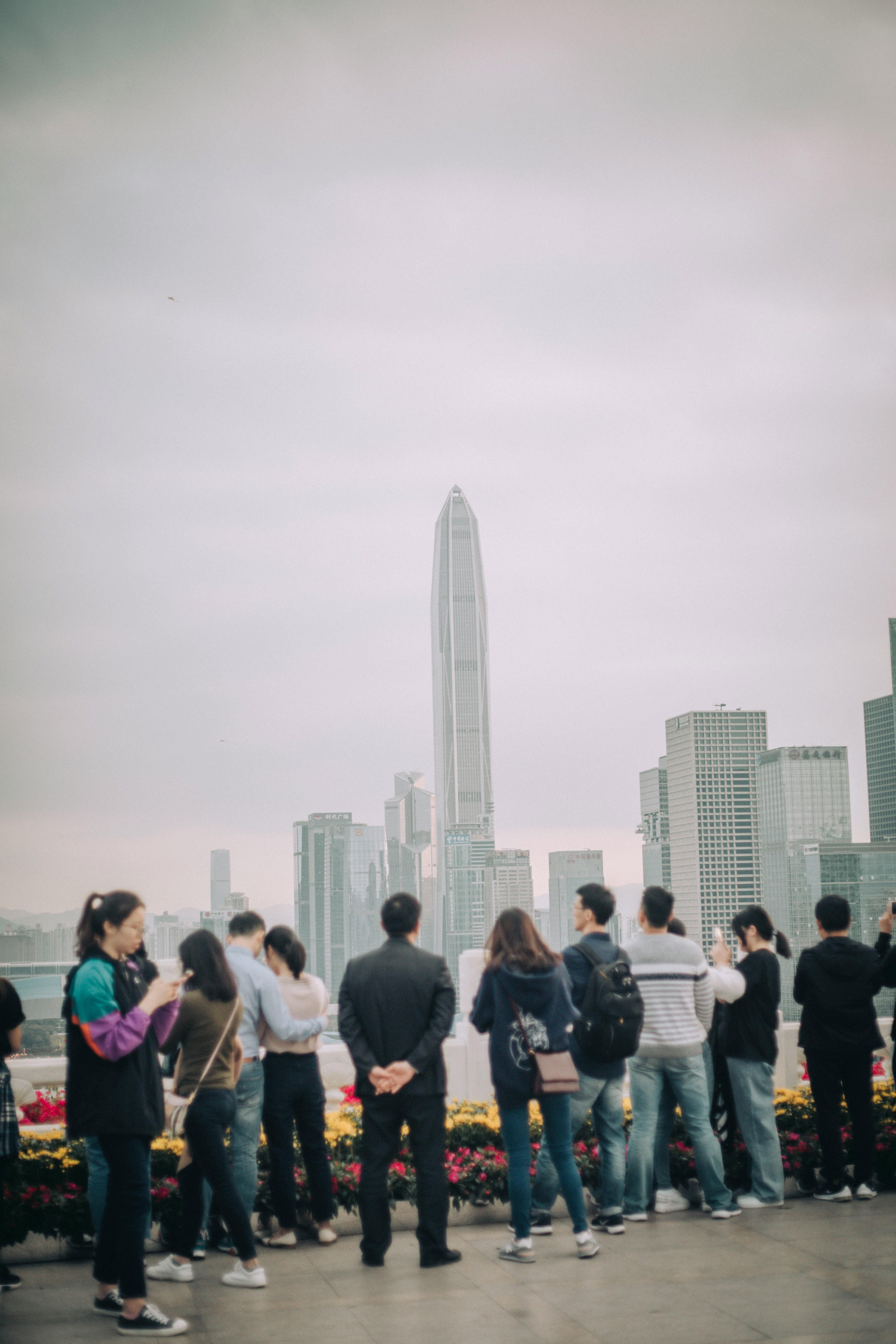 Photo of People Standing Across City Buildings · Free Stock Photo