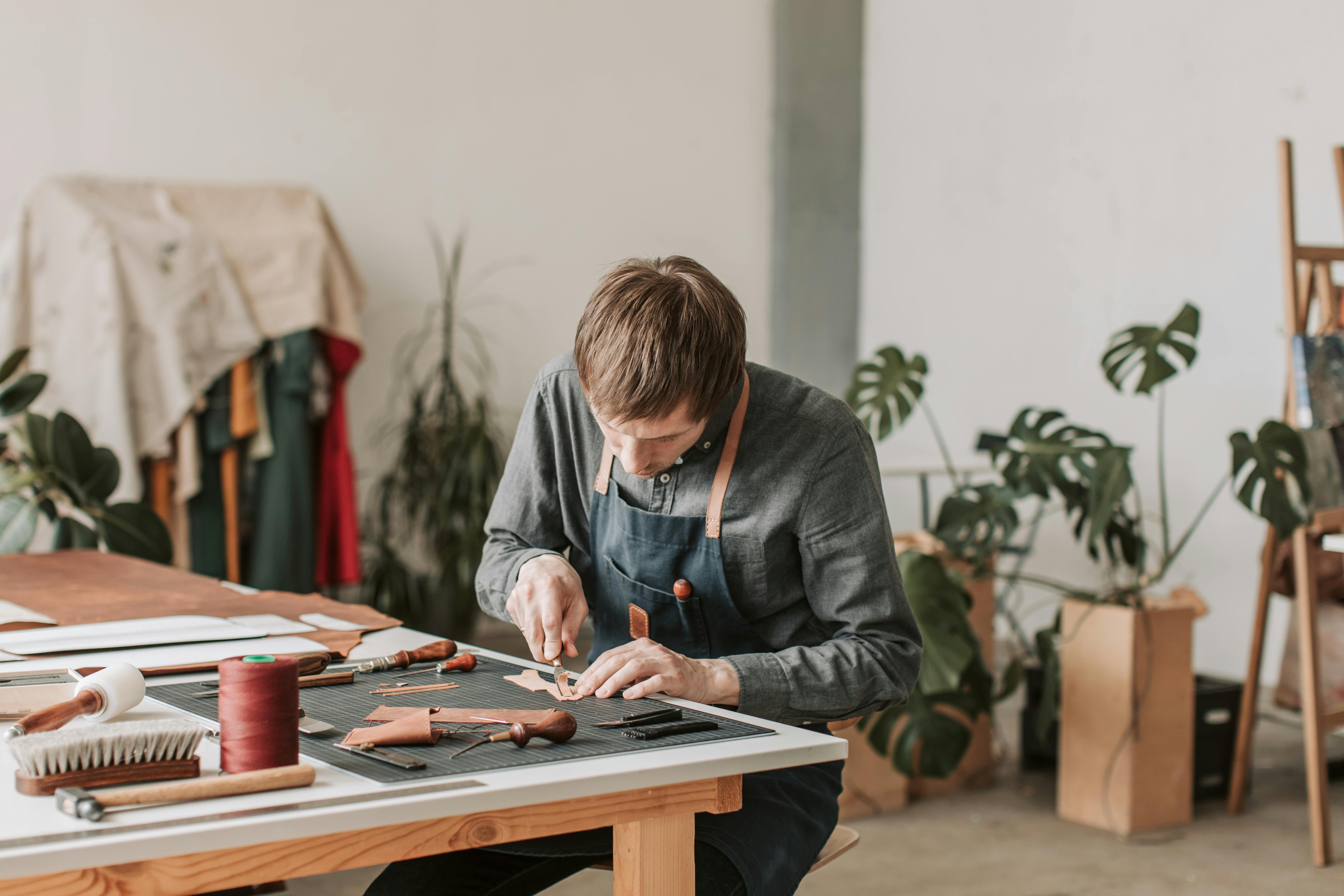 Man Sitting by Table and Working · Free Stock Photo
