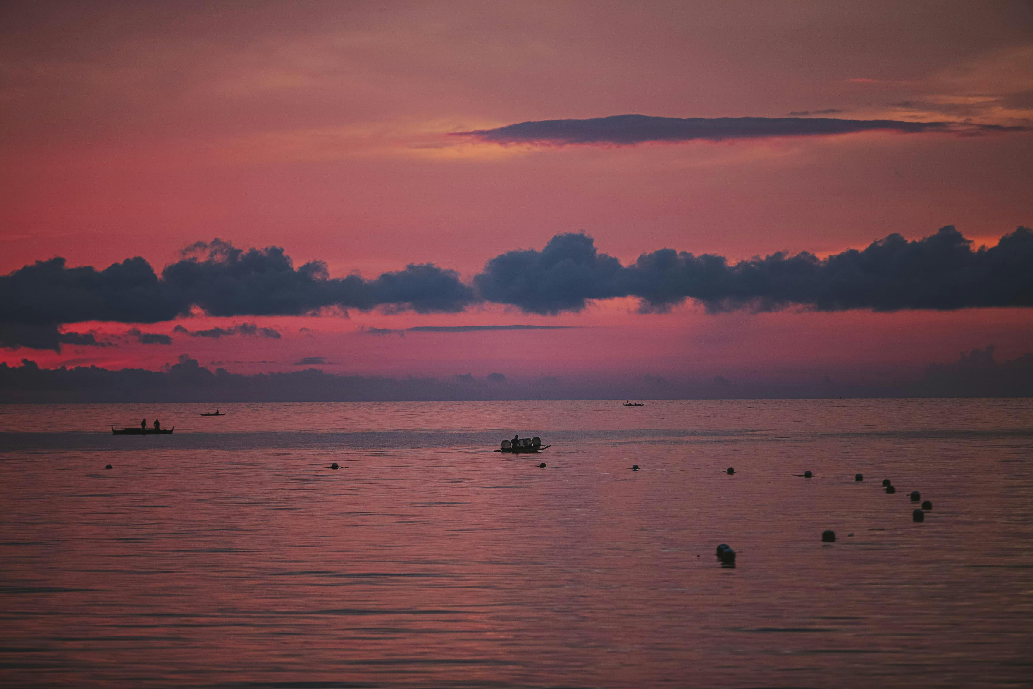 Night sea with boats under sky at sunset · Free Stock Photo
