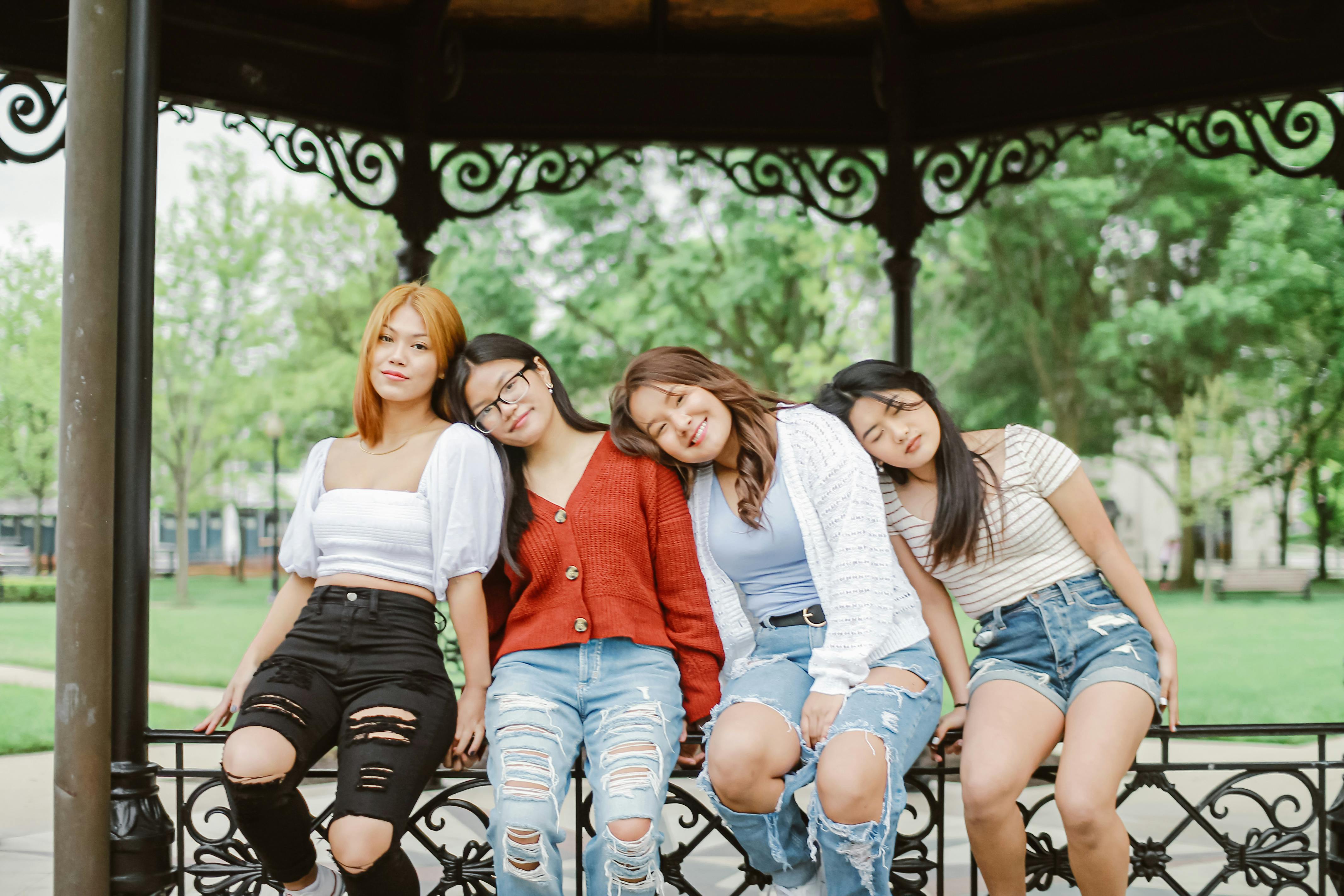 Satisfied stylish woman with cup of beverage on chair · Free Stock Photo