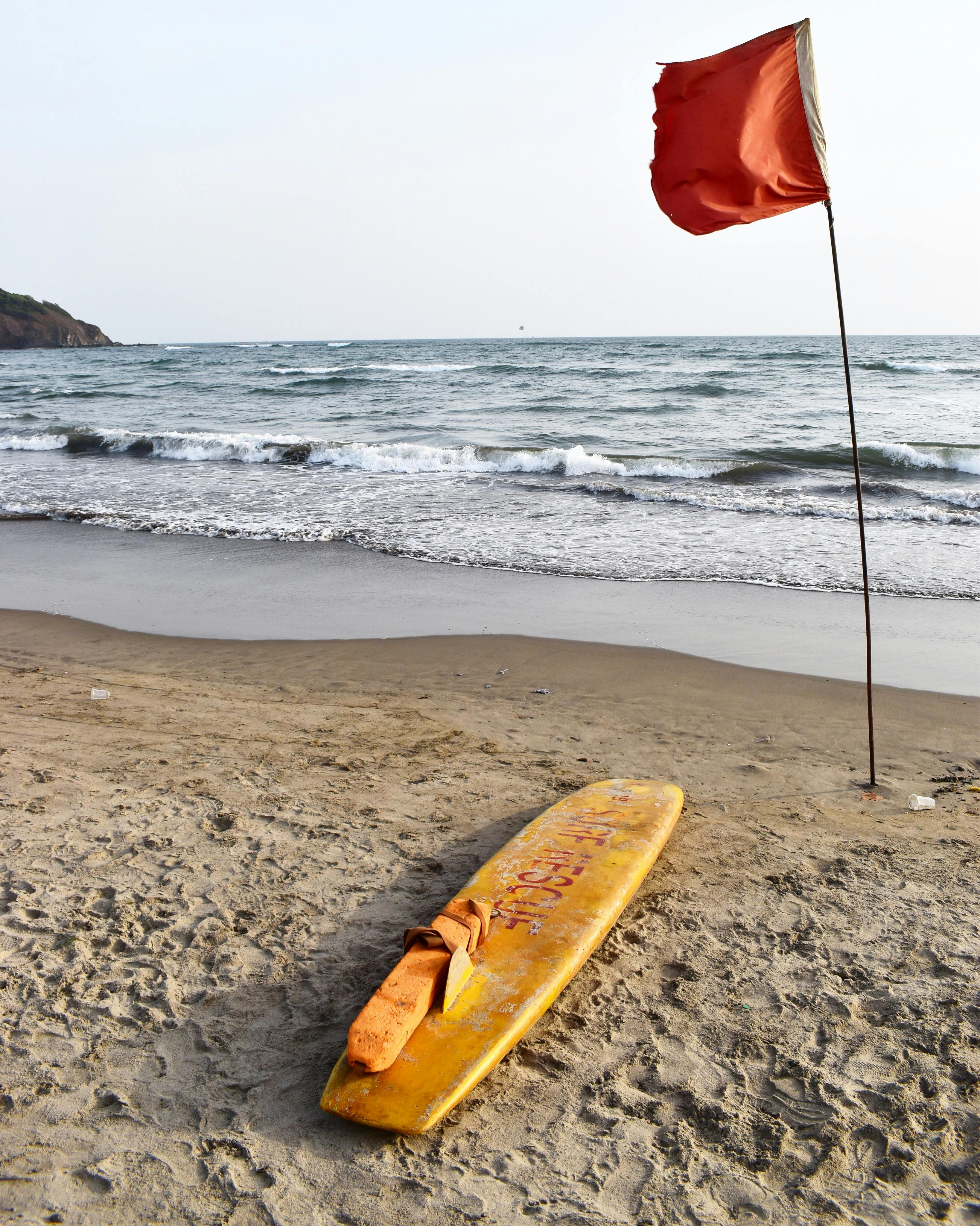 Yellow Surfboard on Beach Shore · Free Stock Photo