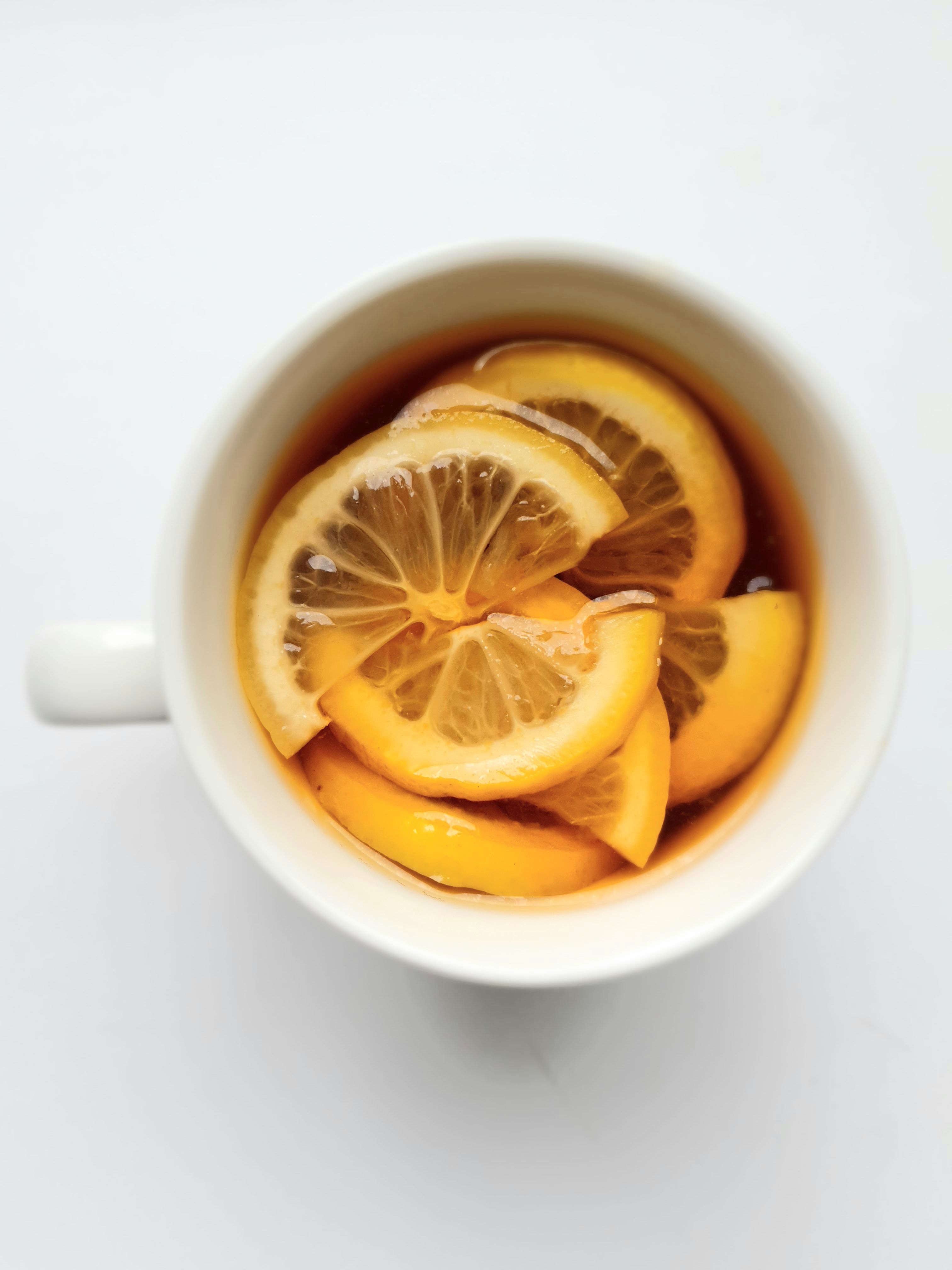 Drink with lemon in cup · Free Stock Photo