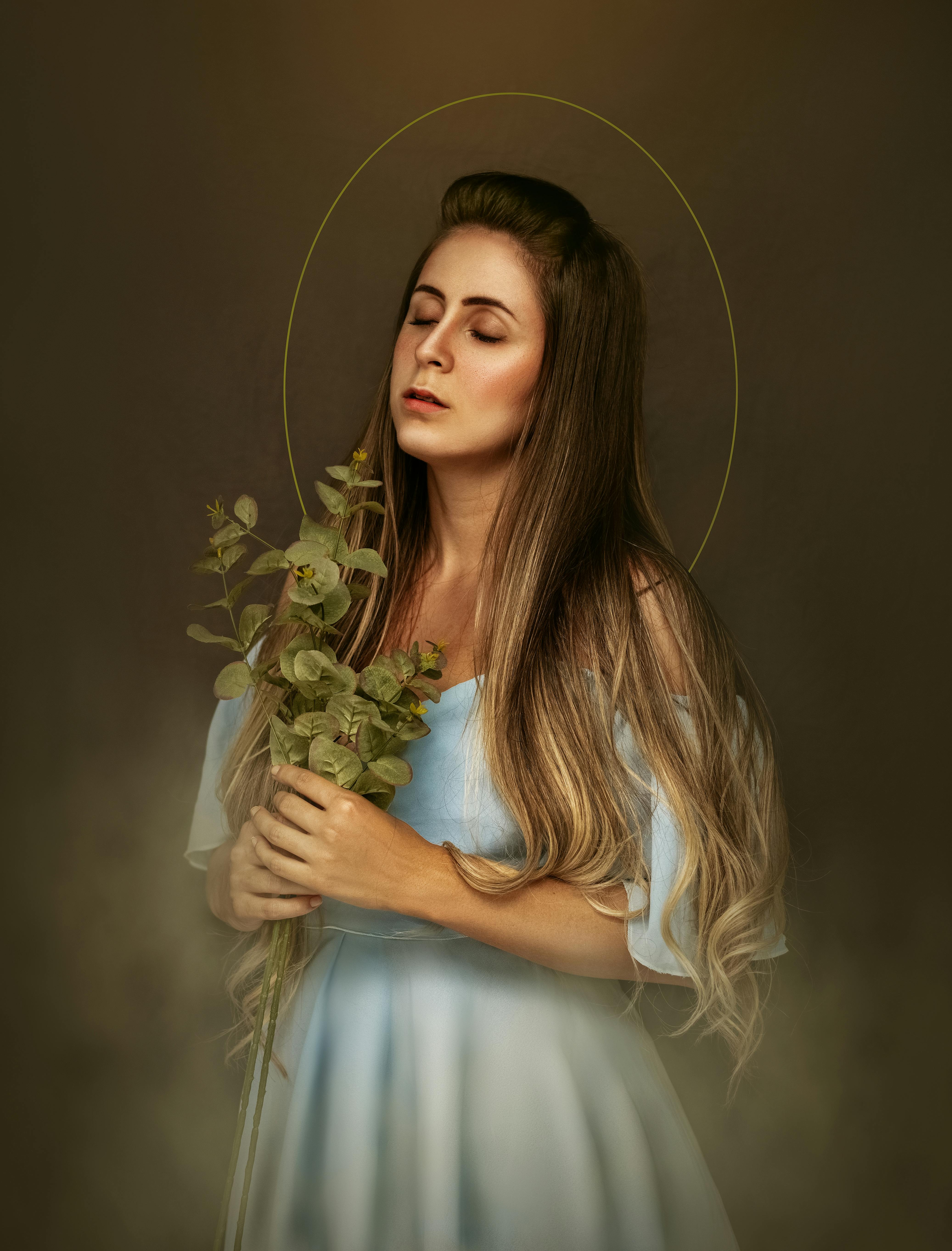 Saint woman with plant twigs · Free Stock Photo