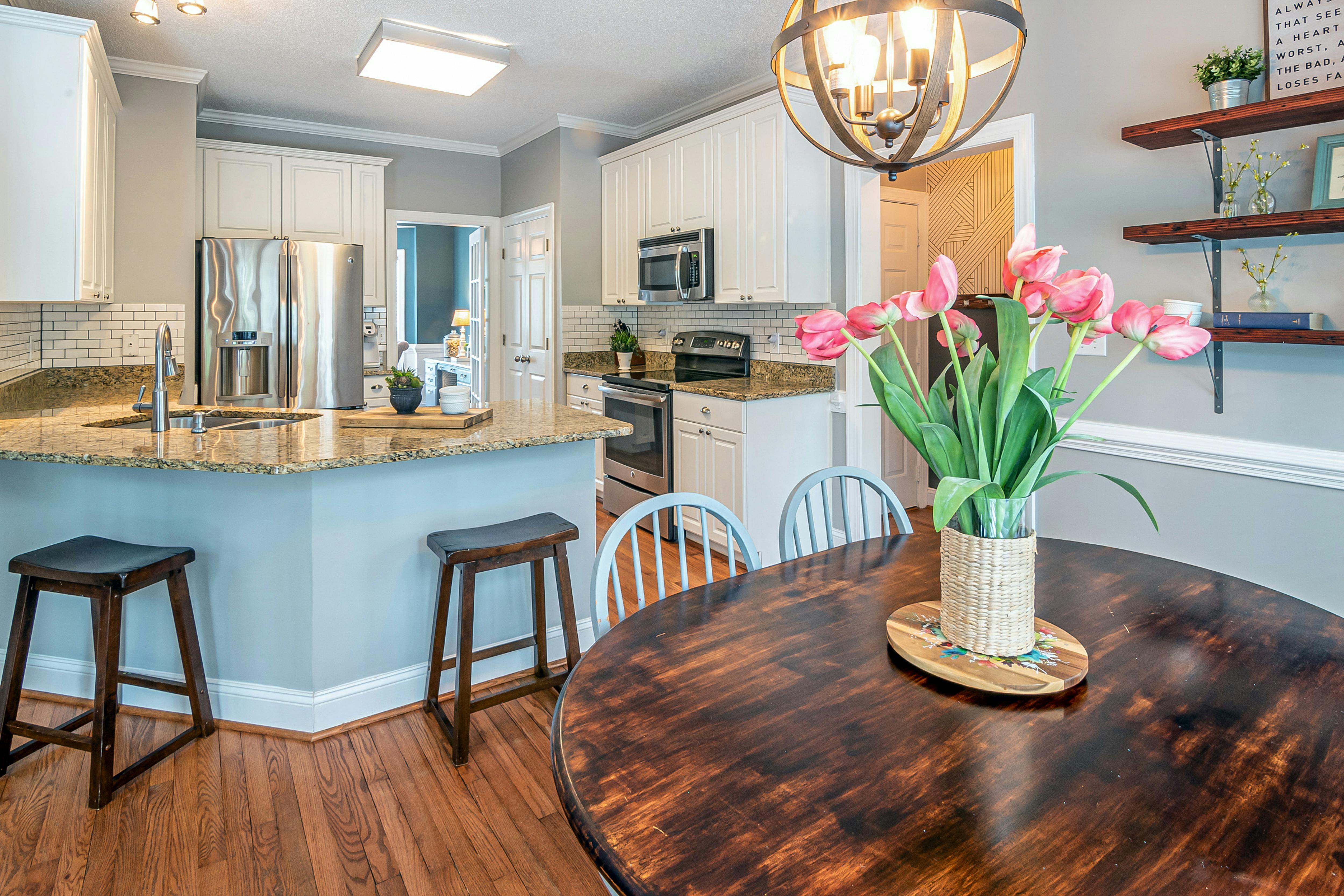 Round Brown Wooden Table Between Two Chairs and Ottoman Chair · Free ...
