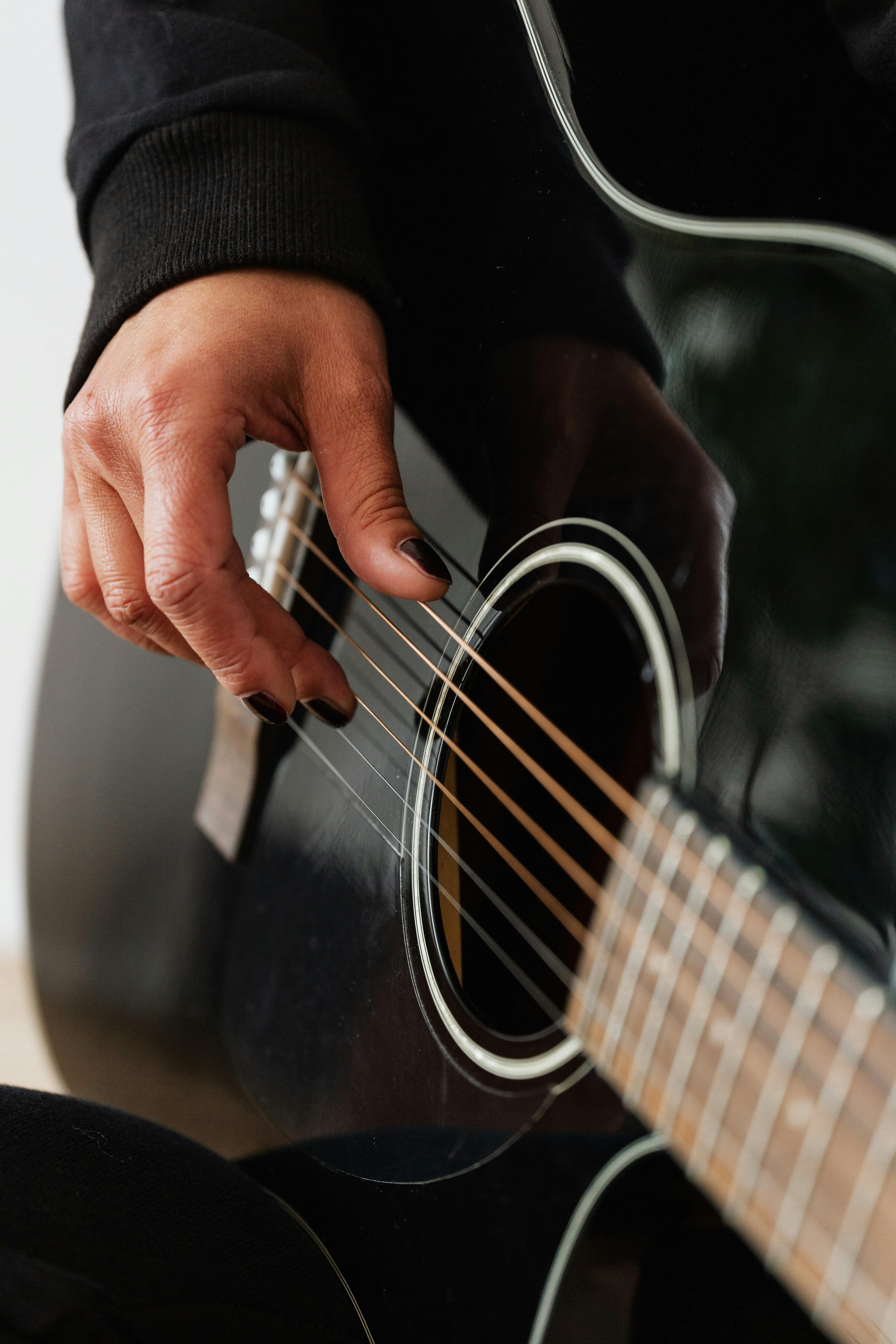 Person Playing Acoustic Guitar · Free Stock Photo