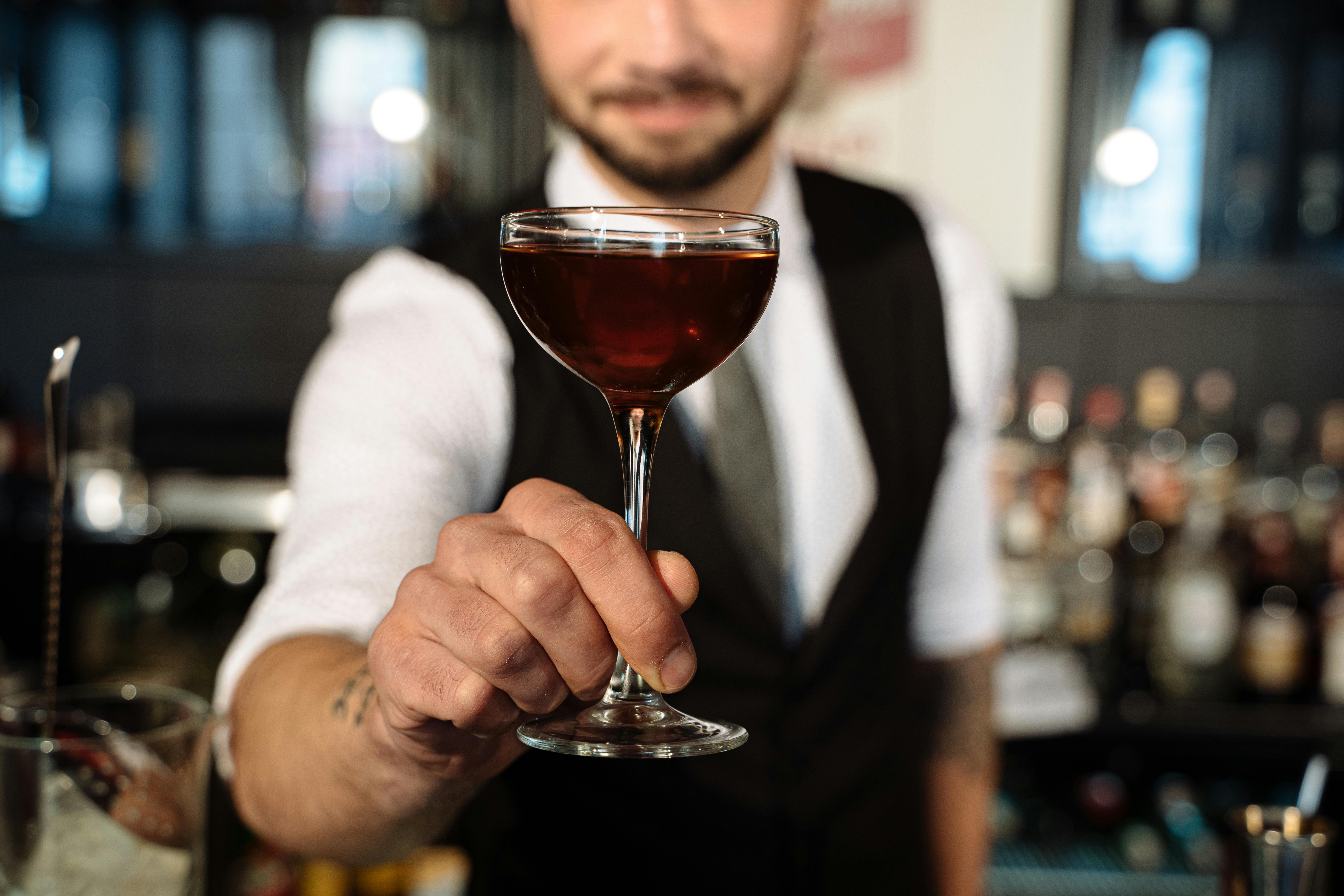 Bartender Holding a Cocktail · Free Stock Photo