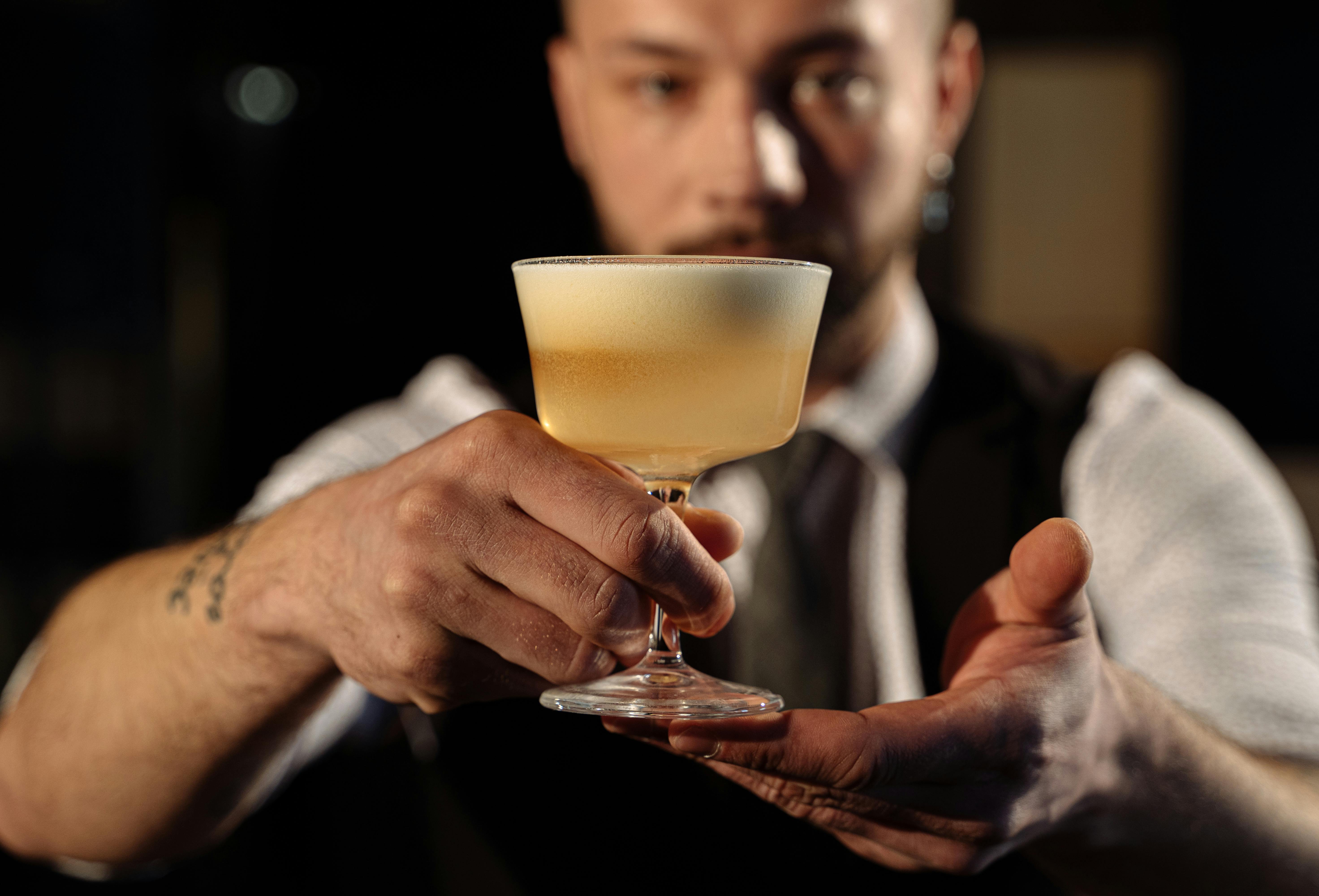 A Bartender Holding a Cocktail Drink · Free Stock Photo