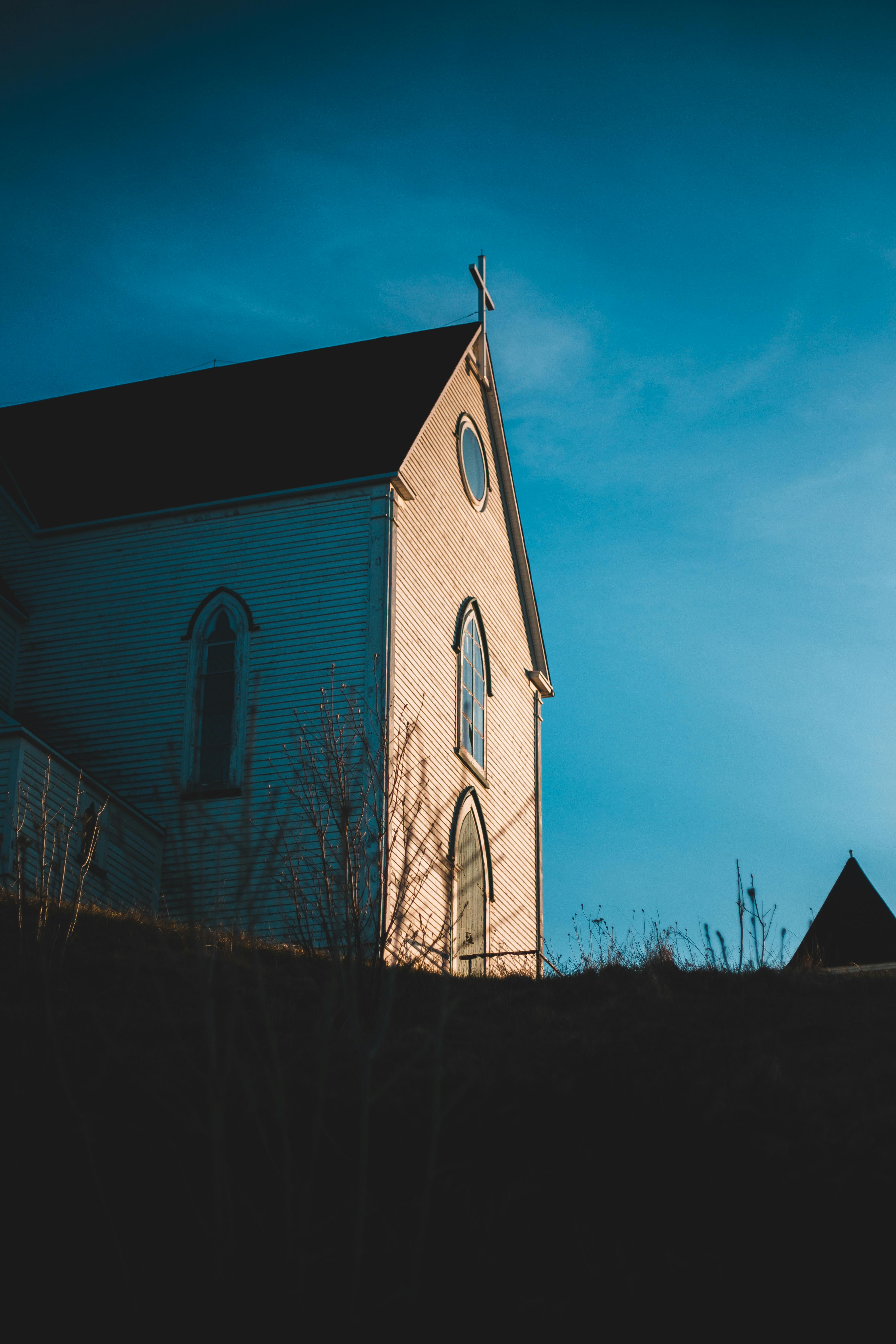 Old masonry church facade under blue sky · Free Stock Photo