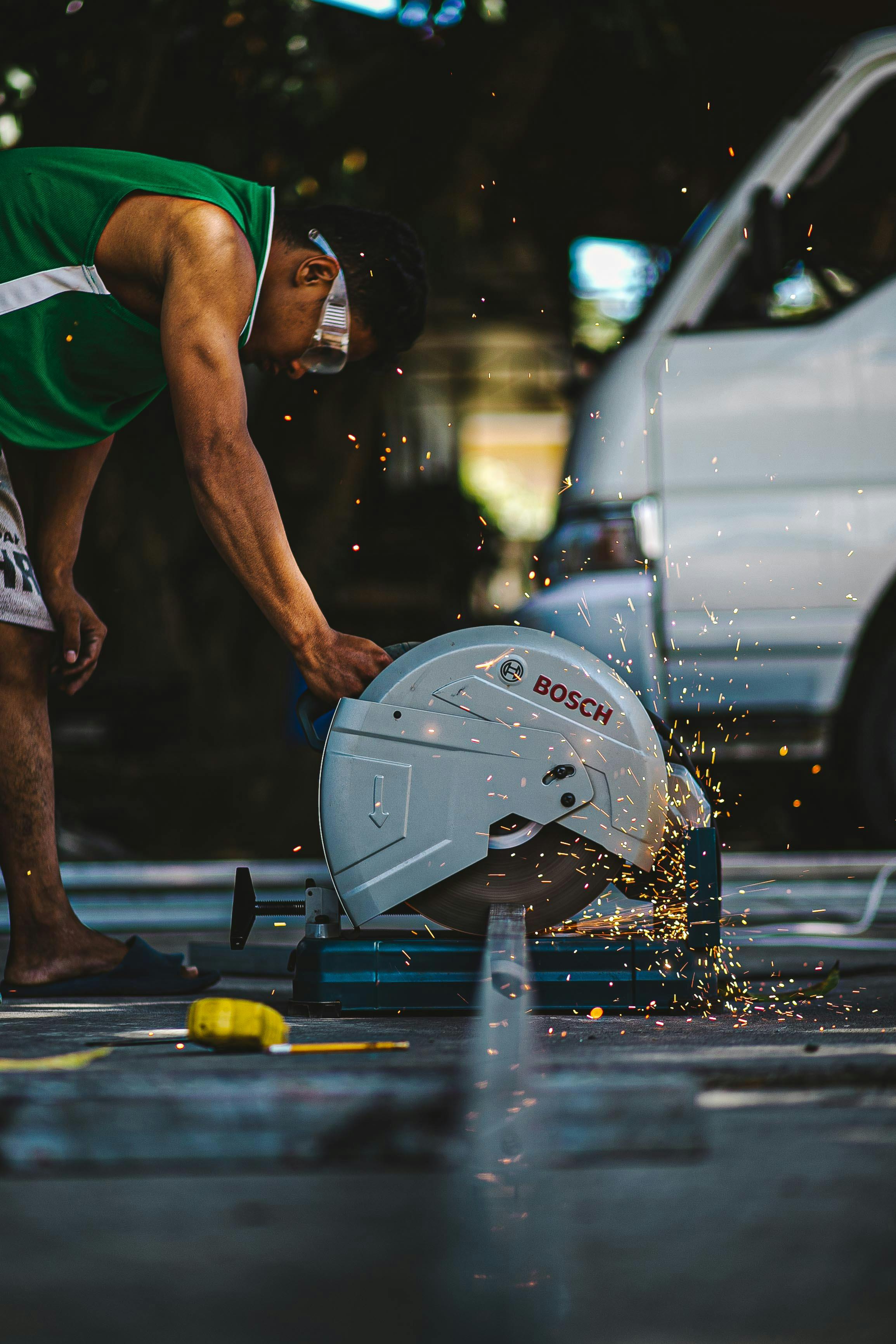 Construction Worker Cutting Metal · Free Stock Photo