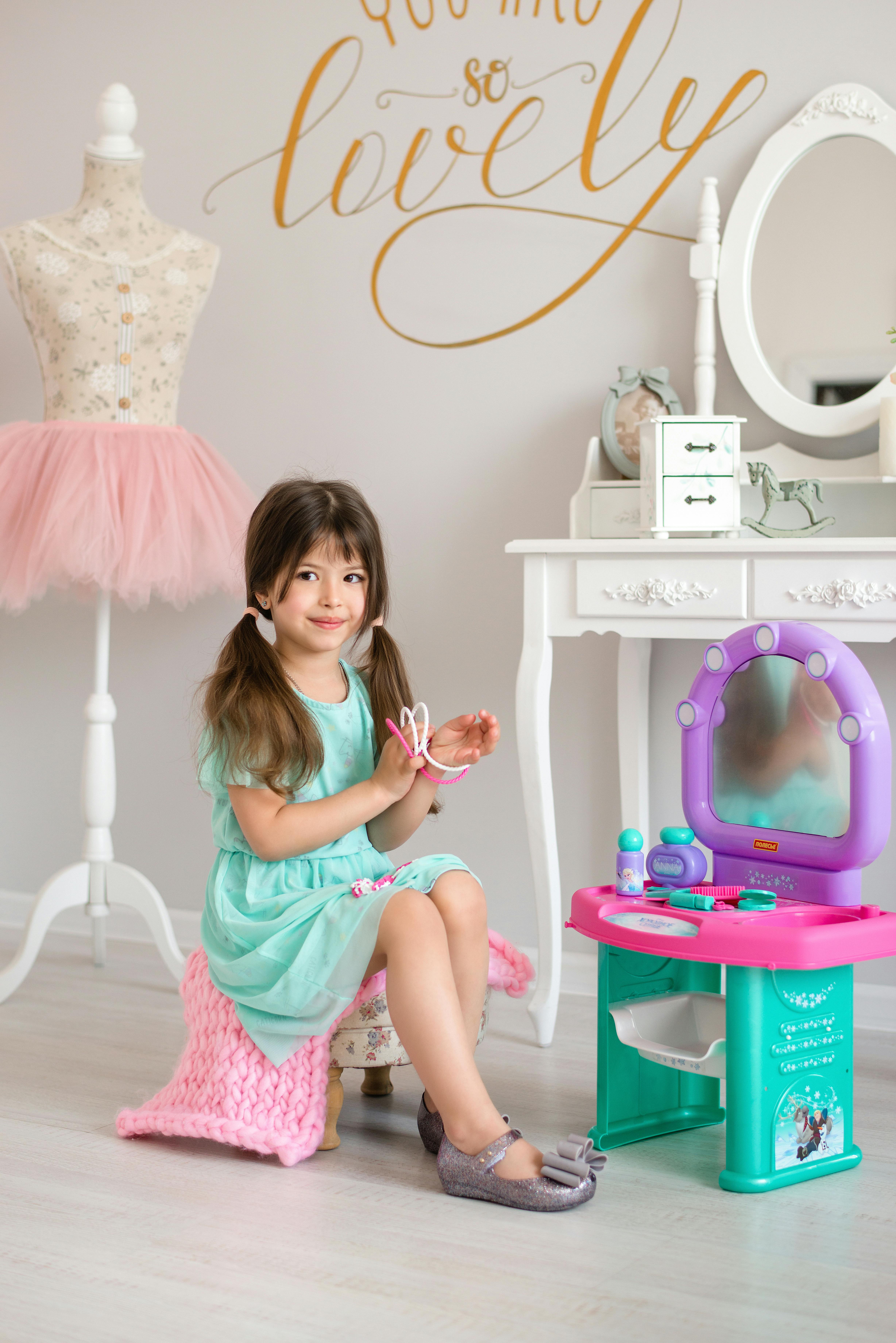 A Little Girl Playing Makeup · Free Stock Photo