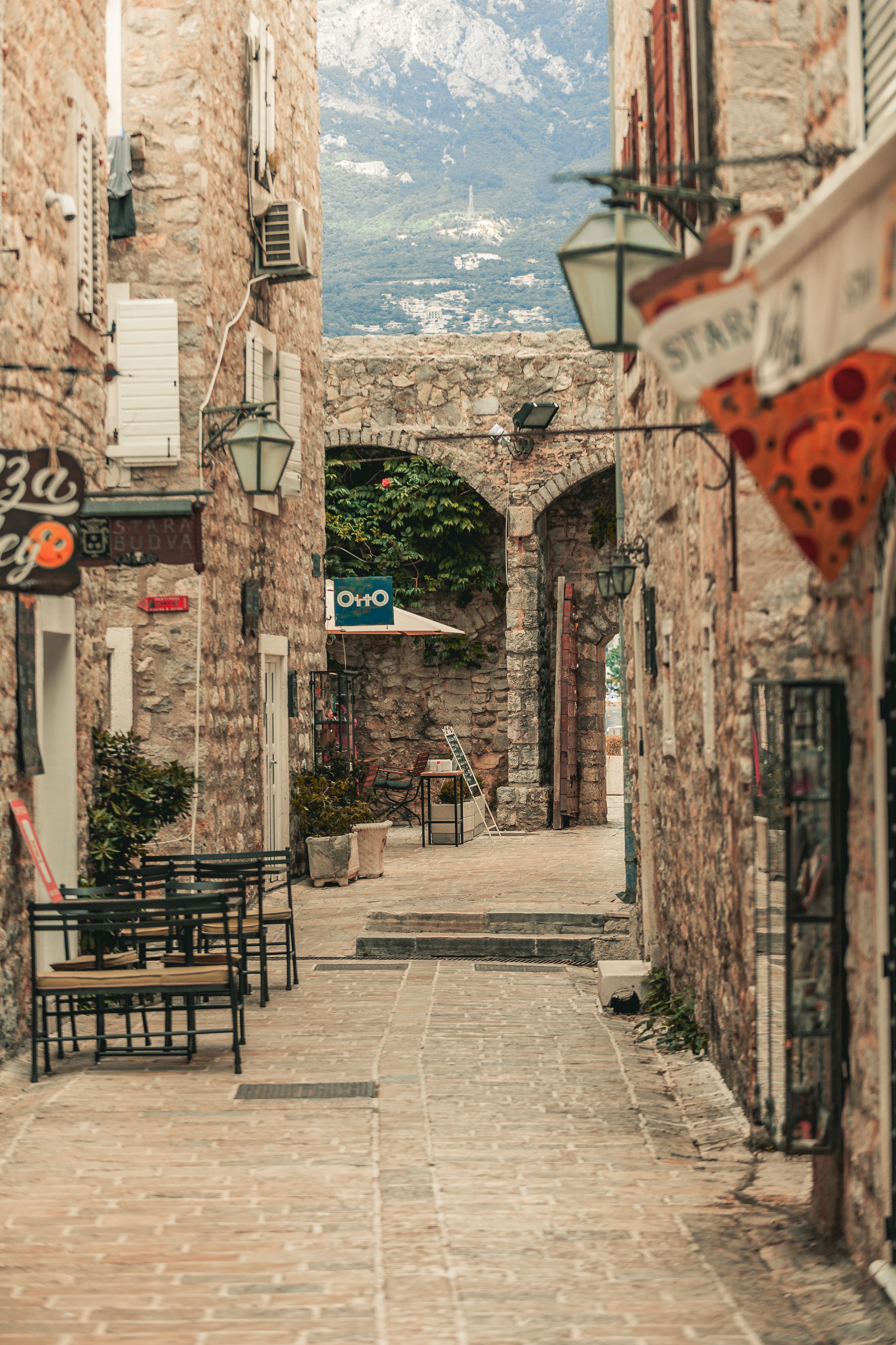 Old narrow street between shabby houses behind mount · Free Stock Photo
