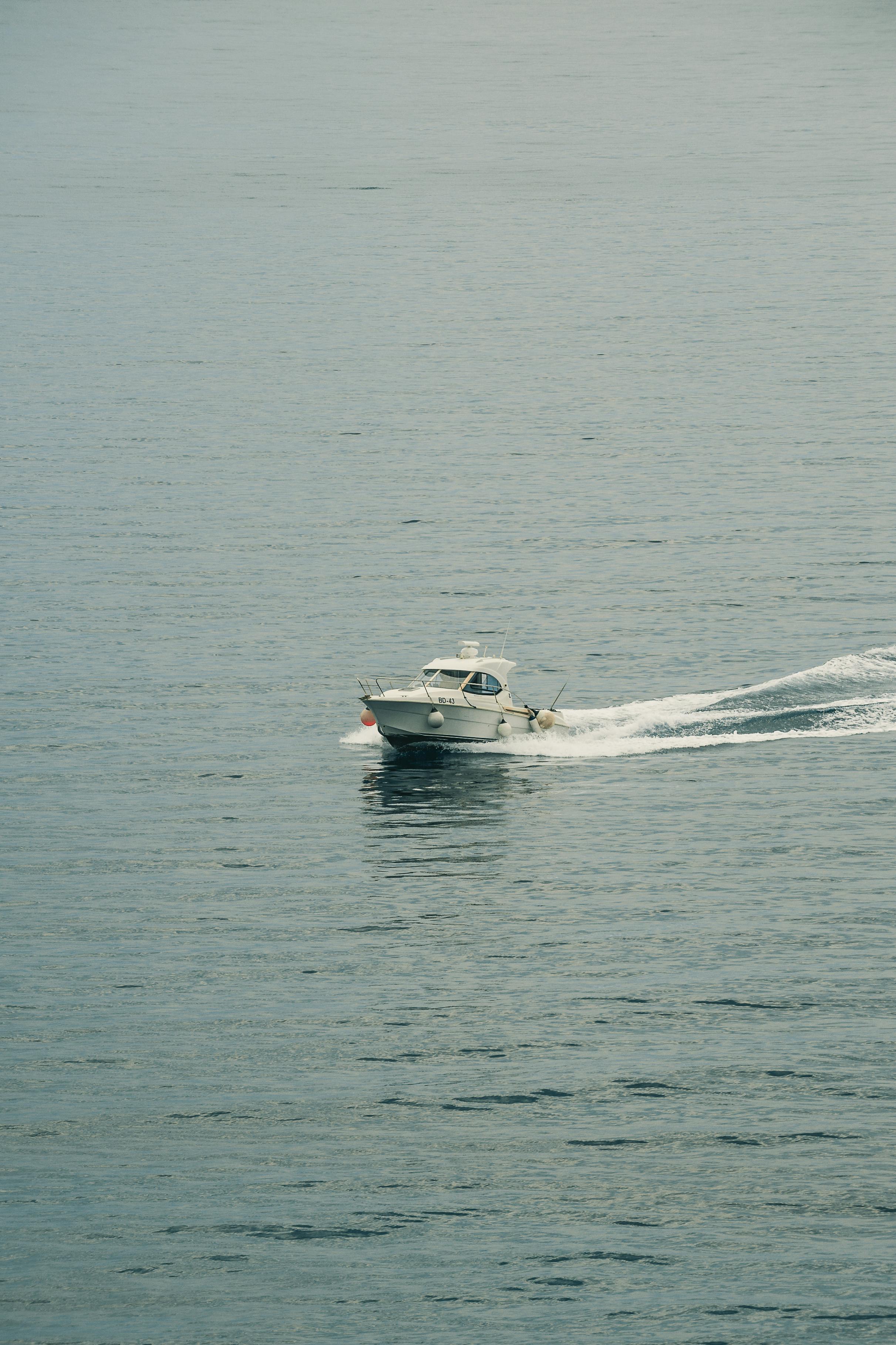 Fast motor boat sailing on ocean in afternoon · Free Stock Photo