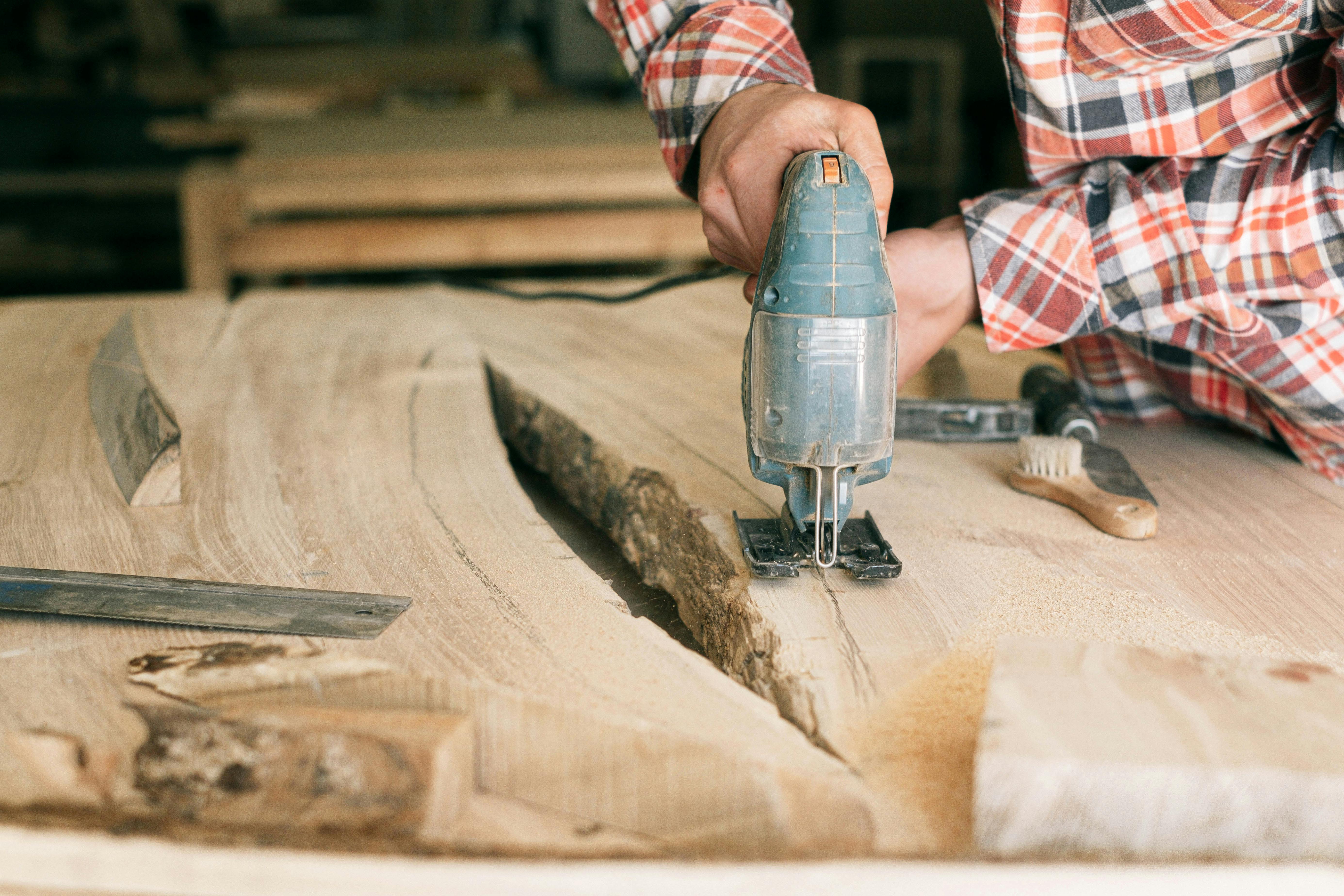 A Person Cutting a Wood · Free Stock Photo