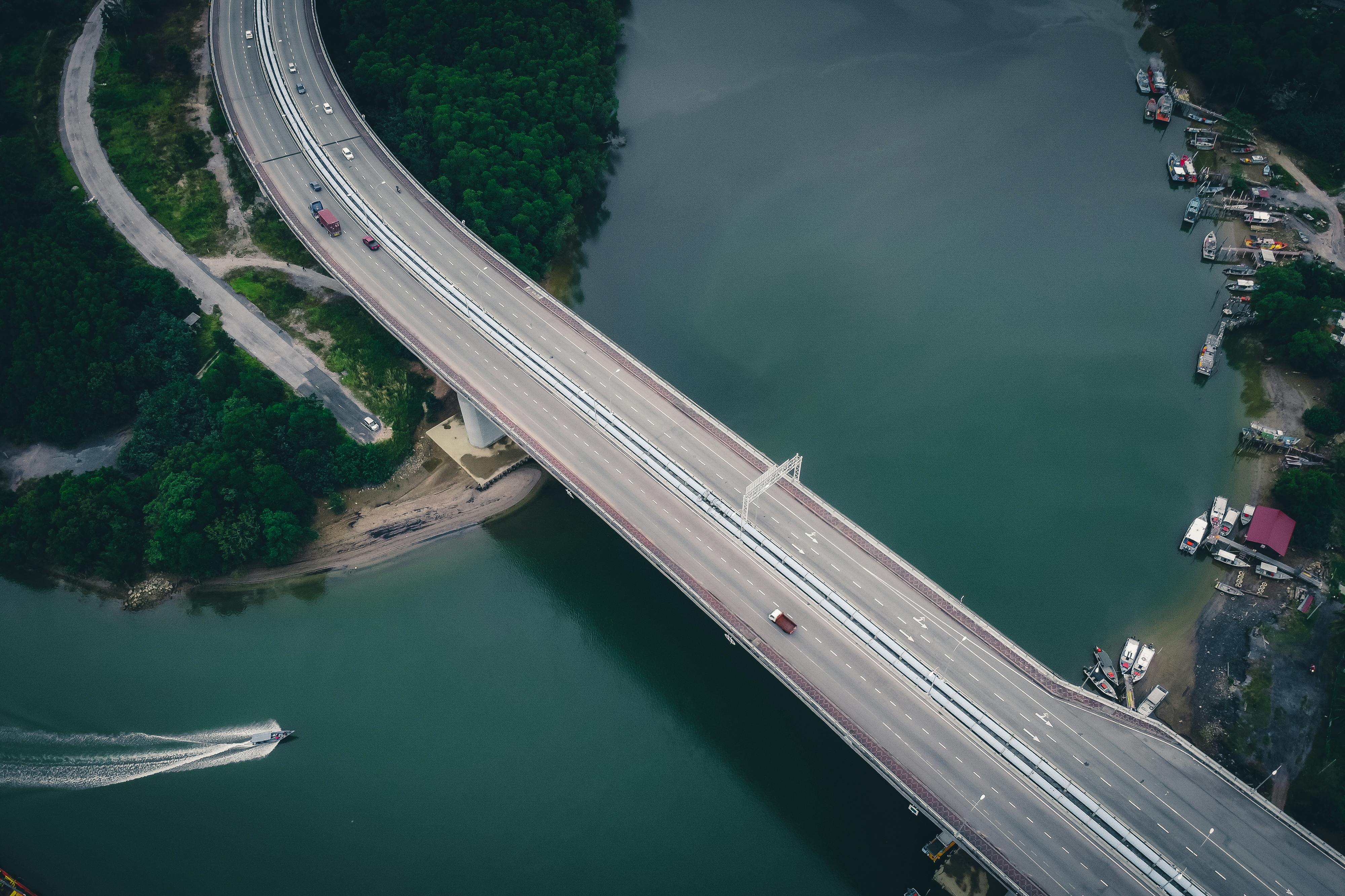 Cars driving on bridge over river · Free Stock Photo