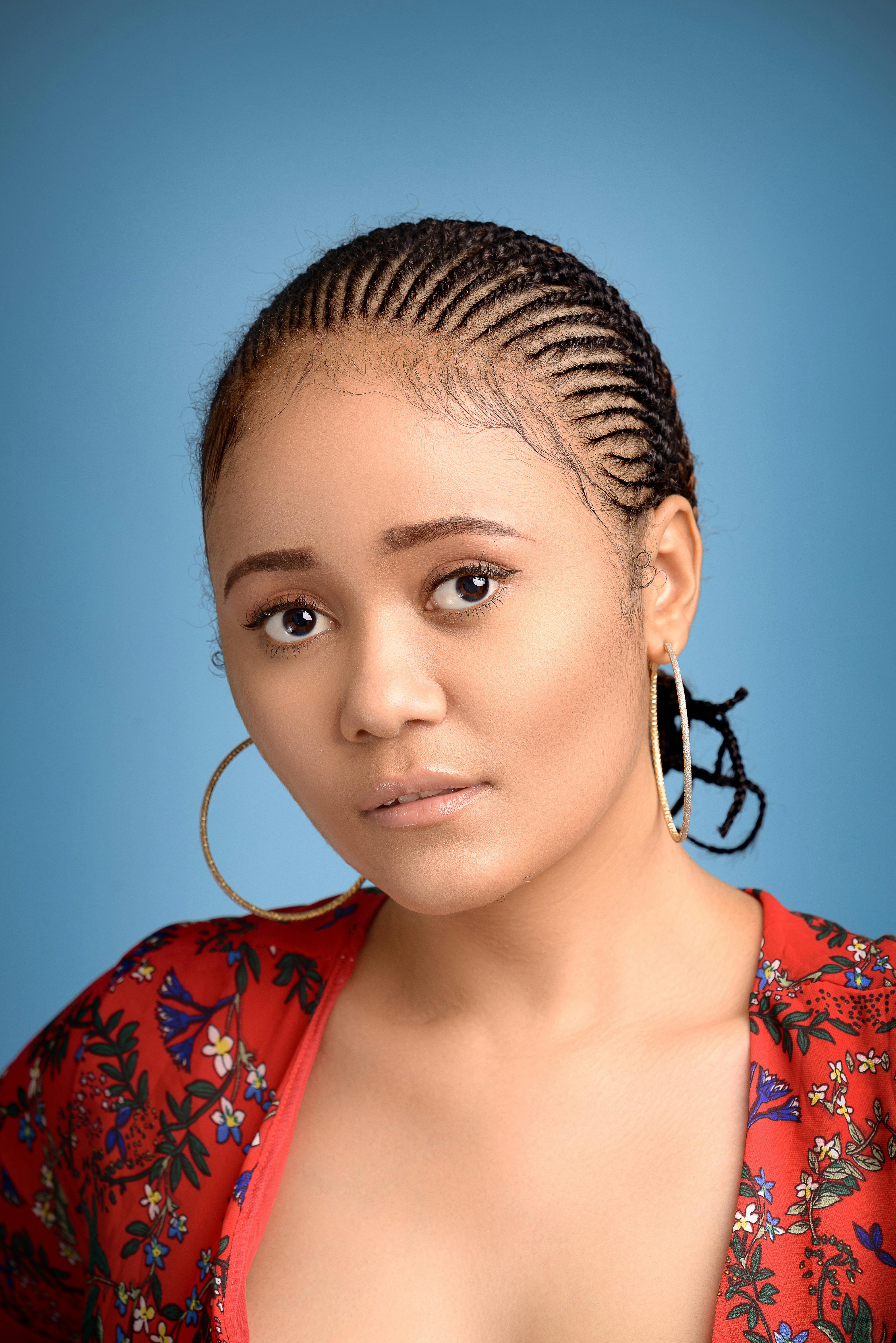 Emotionless young lady with smears on painted face looking away in ...