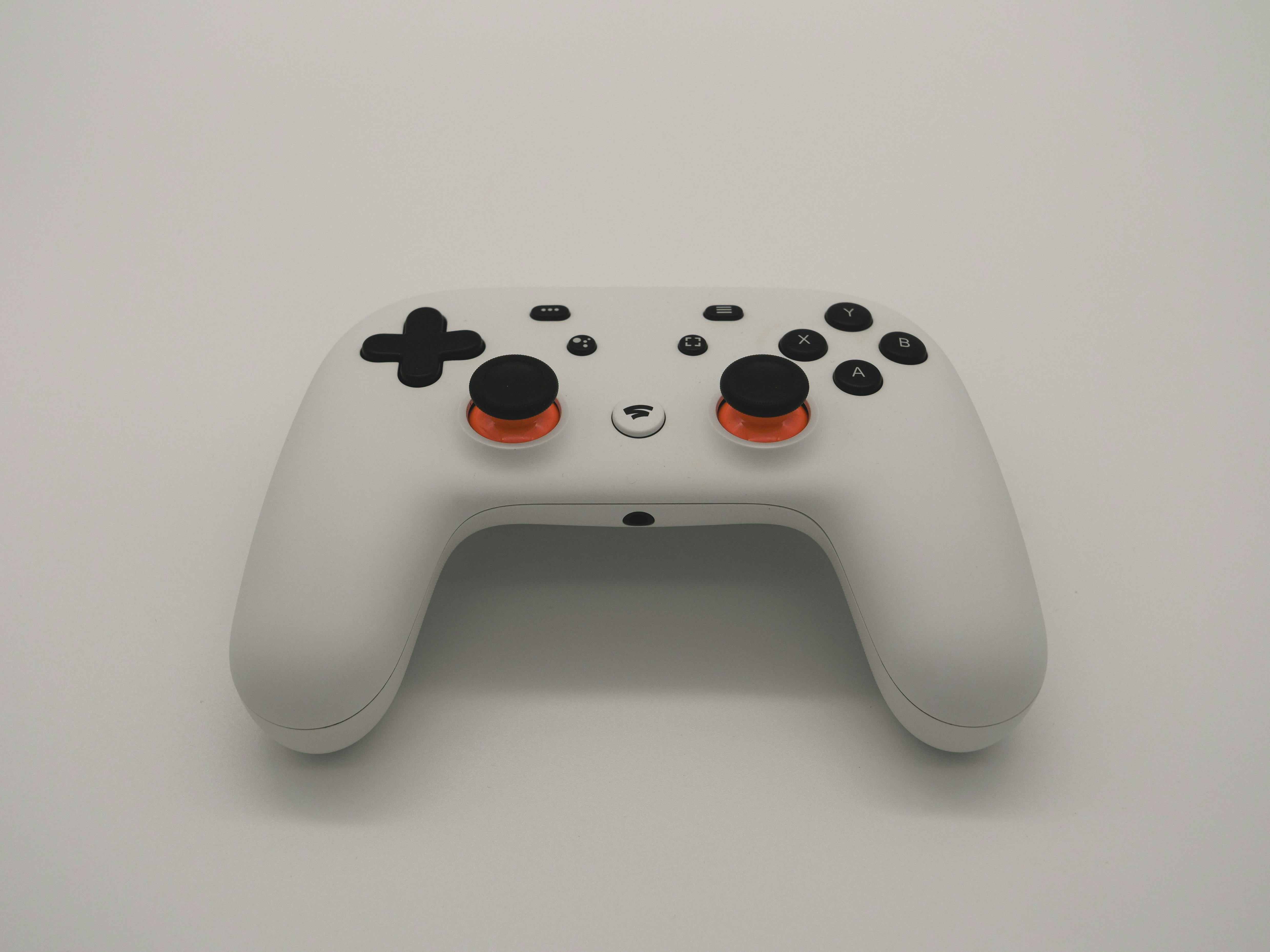A White Gaming Controller on a White Surface · Free Stock Photo