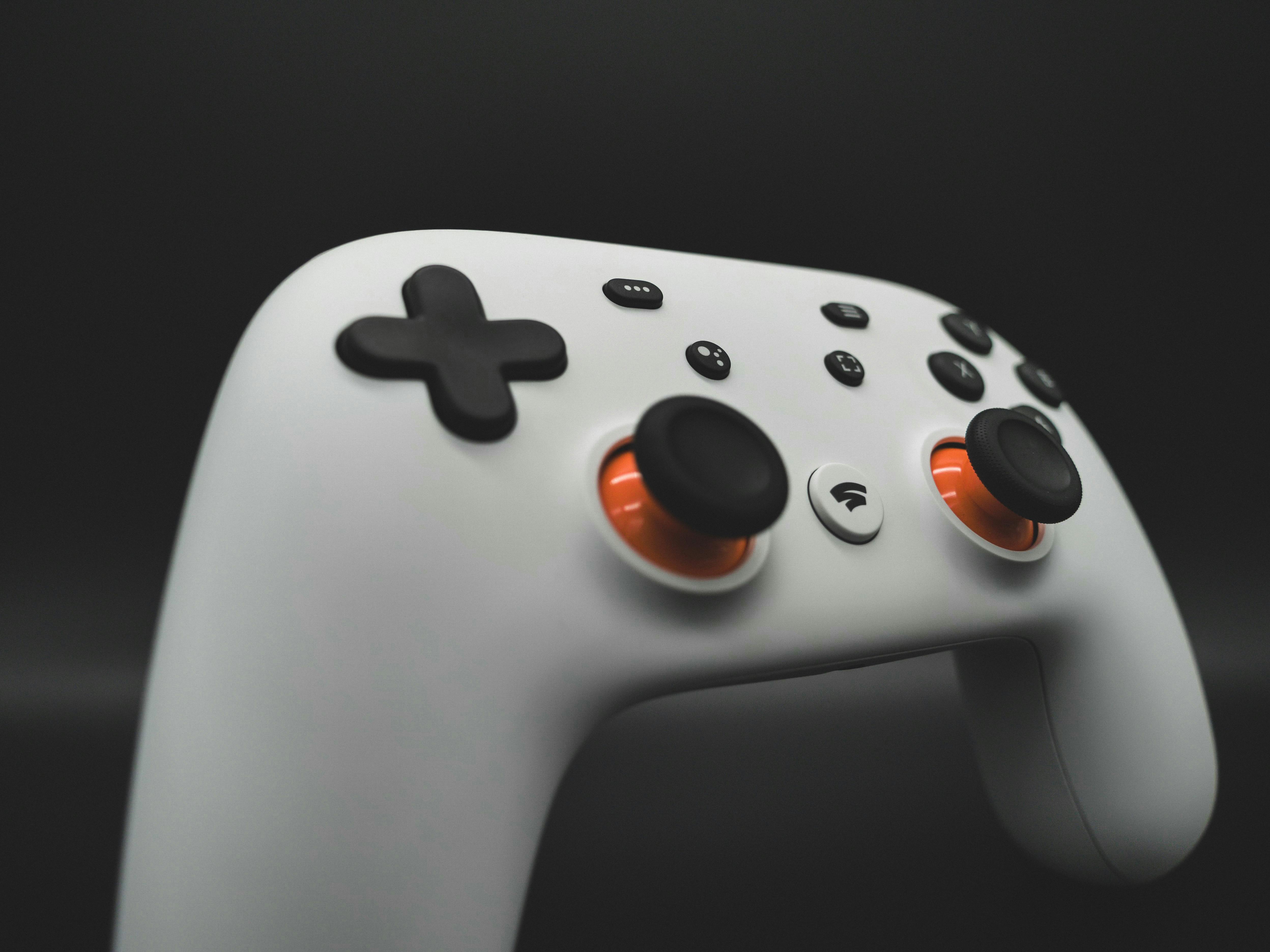 Messy Table with Game Controllers and a Beer Bottle · Free Stock Photo