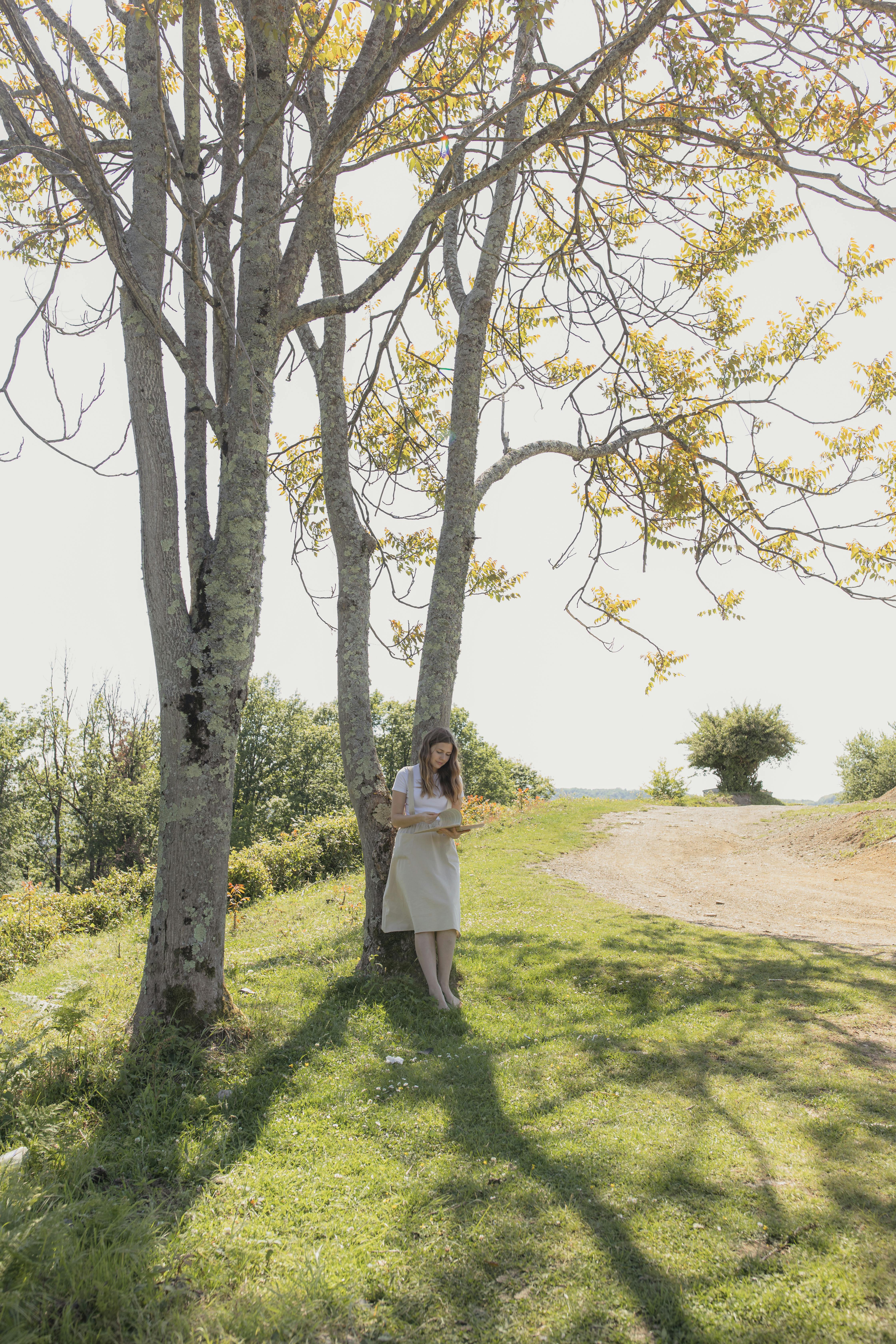 Woman Standing Beside Tree · Free Stock Photo