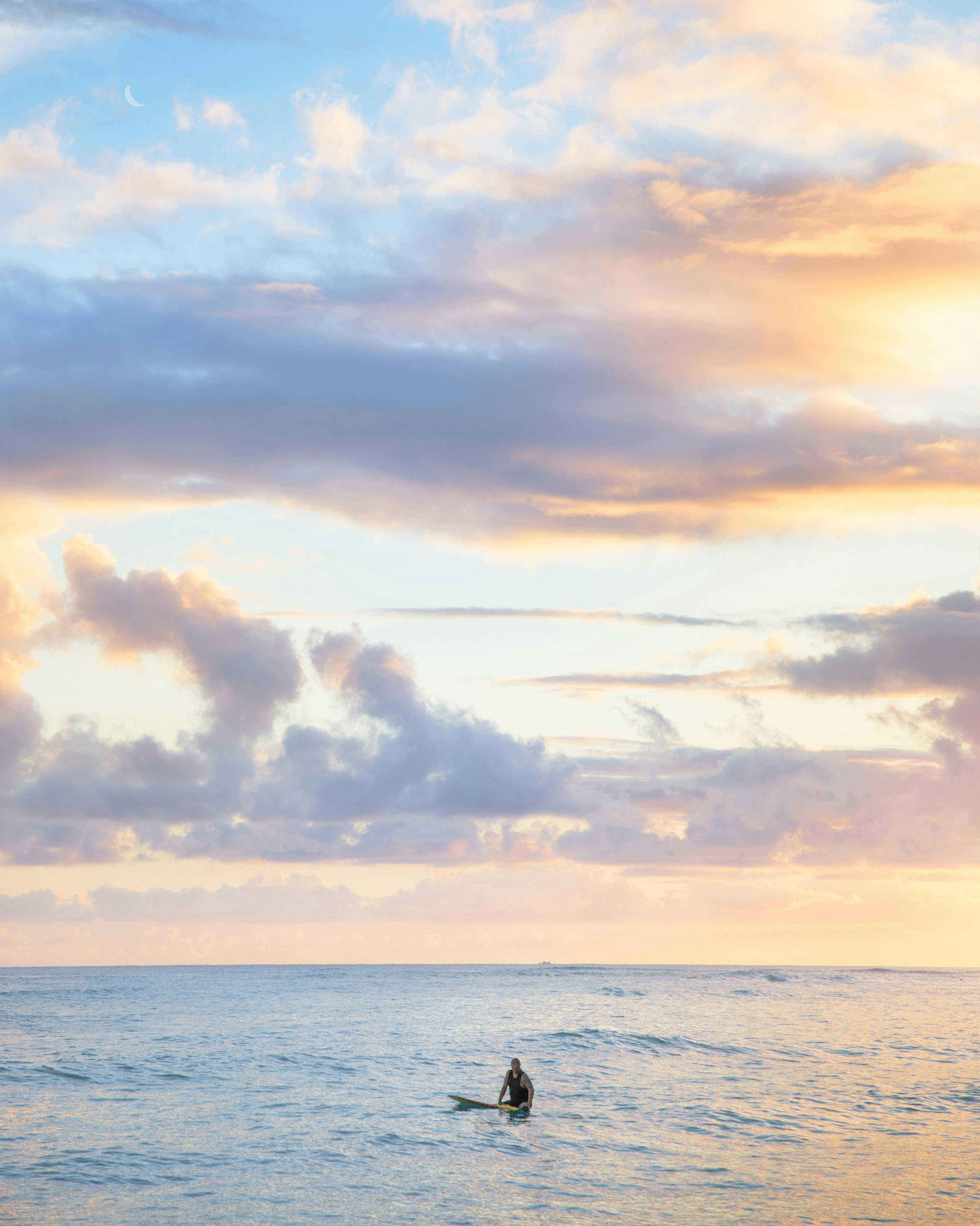 Person Holding a Surfboard at Sea · Free Stock Photo