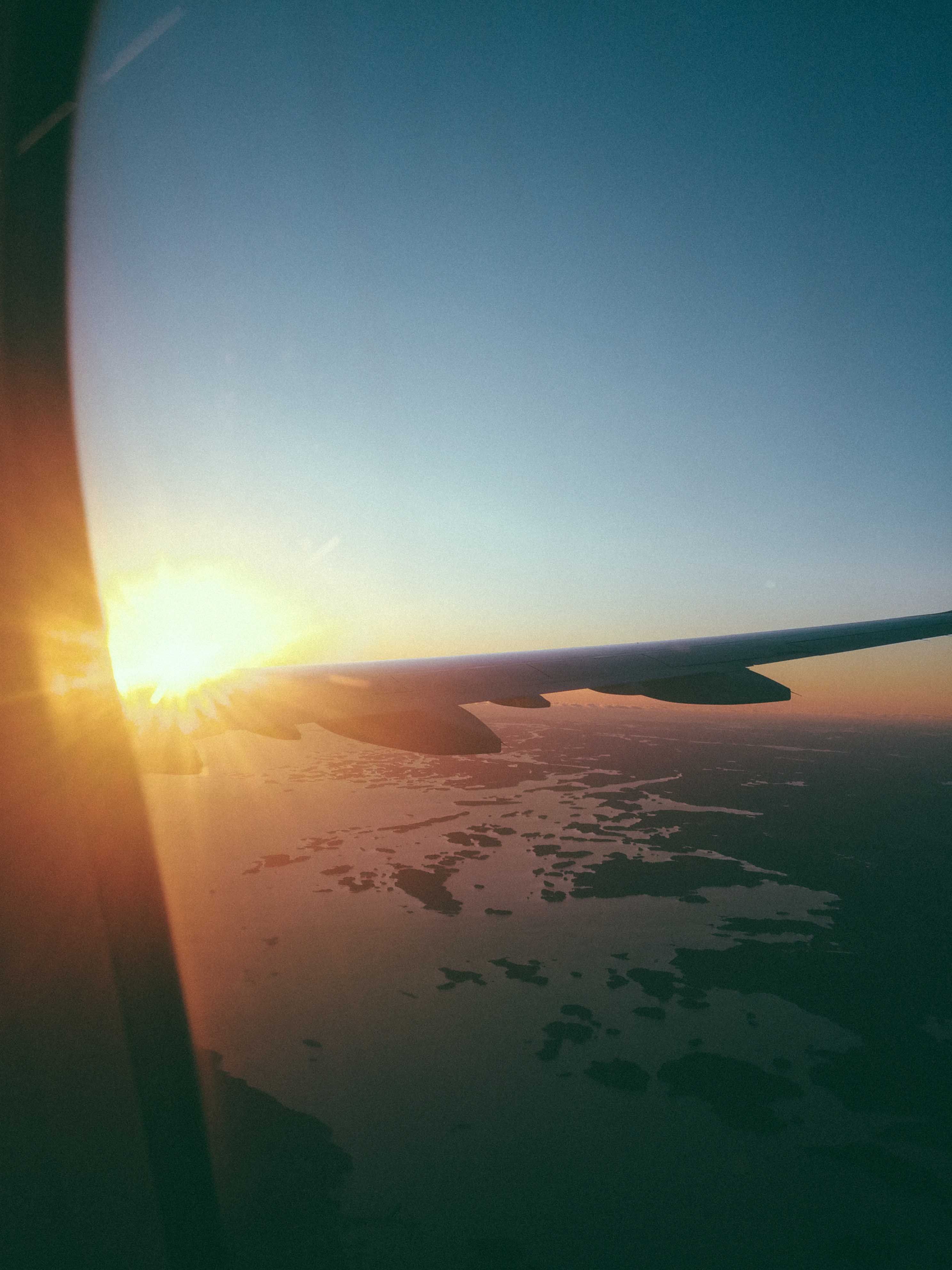 Airplane Window View of Sunrise · Free Stock Photo