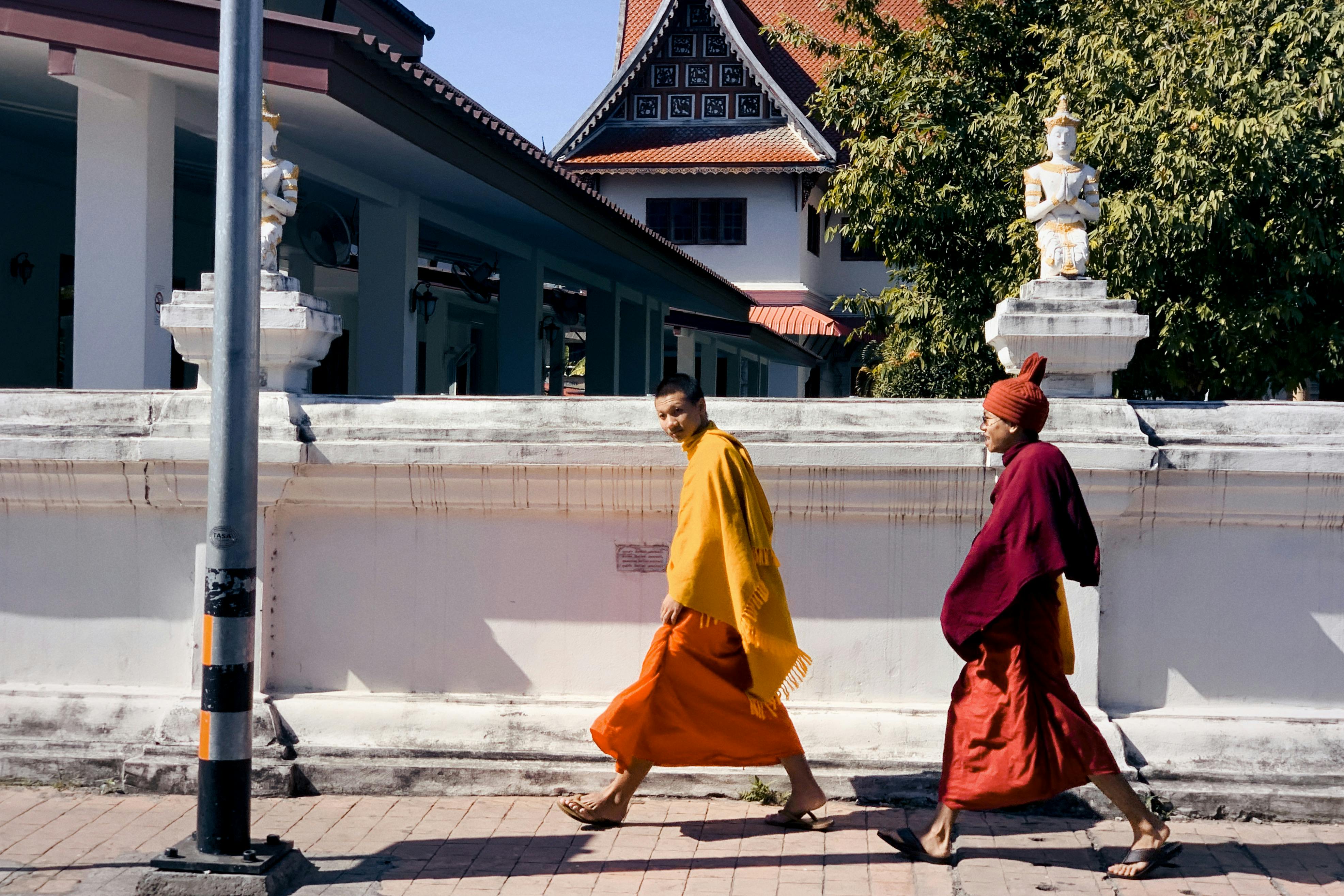 Photo of Two Monks Walking on the Street · Free Stock Photo