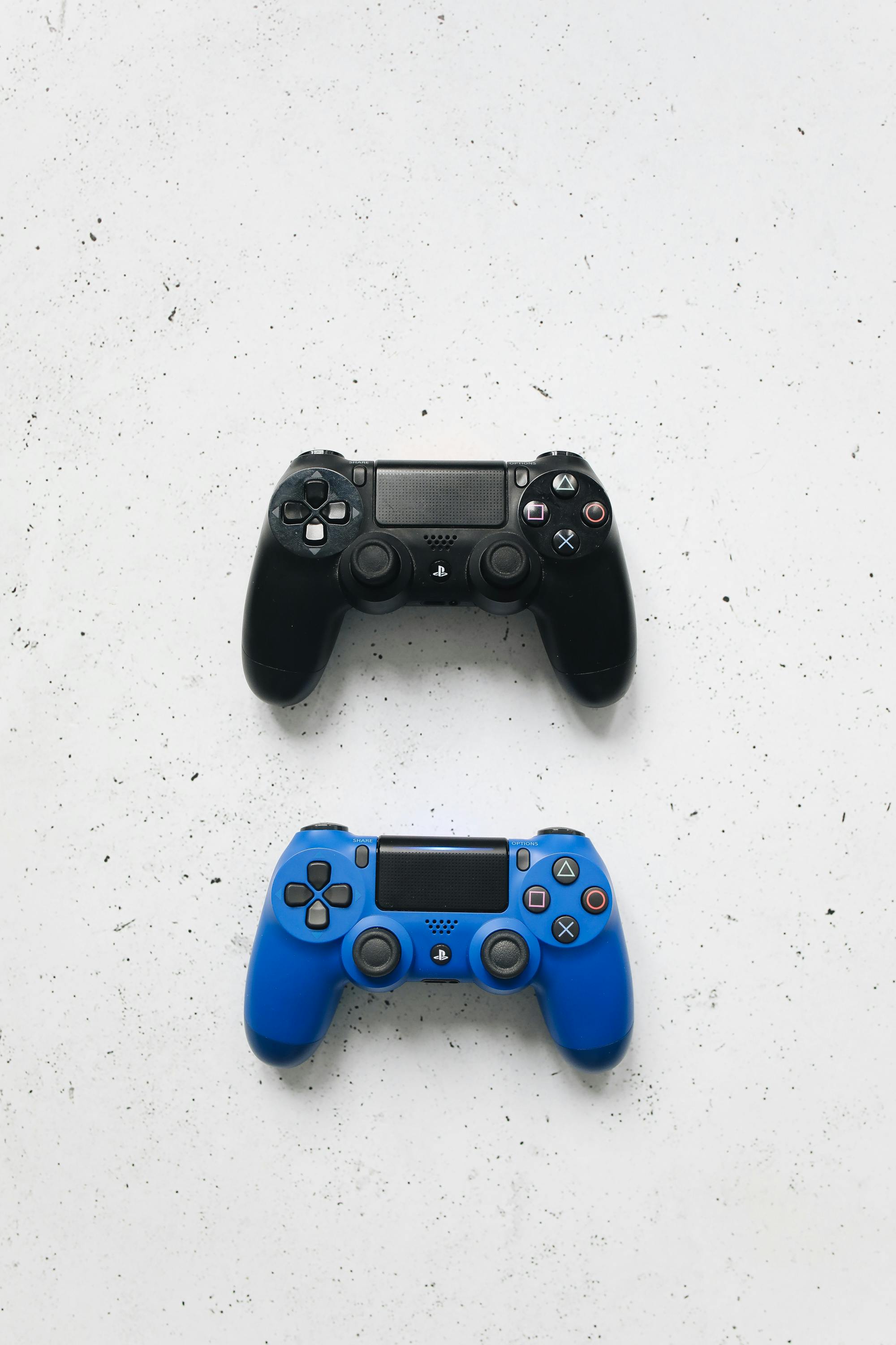 Black and Blue Console Controllers · Free Stock Photo