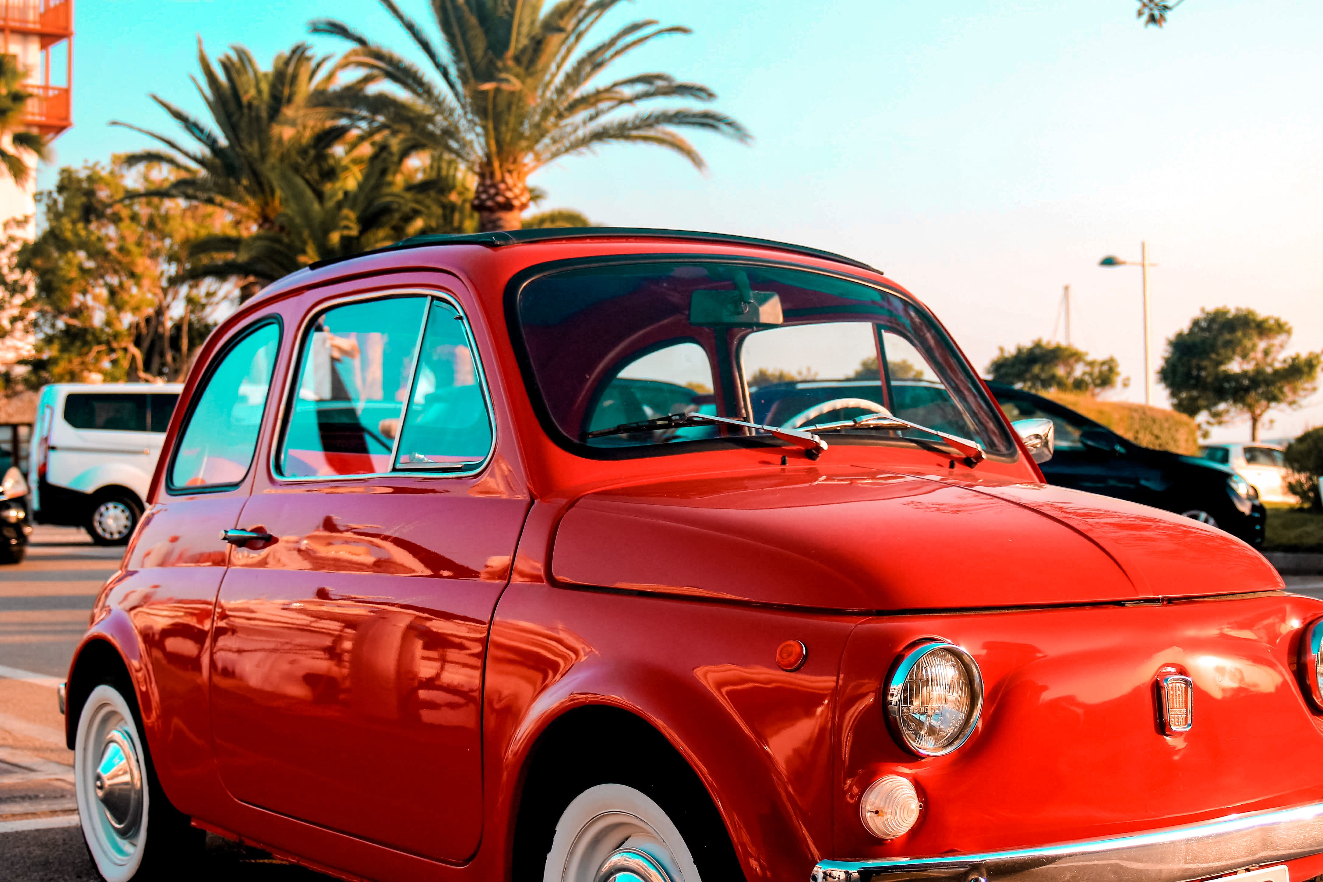 Businessman in sunglasses driving retro car in town · Free Stock Photo