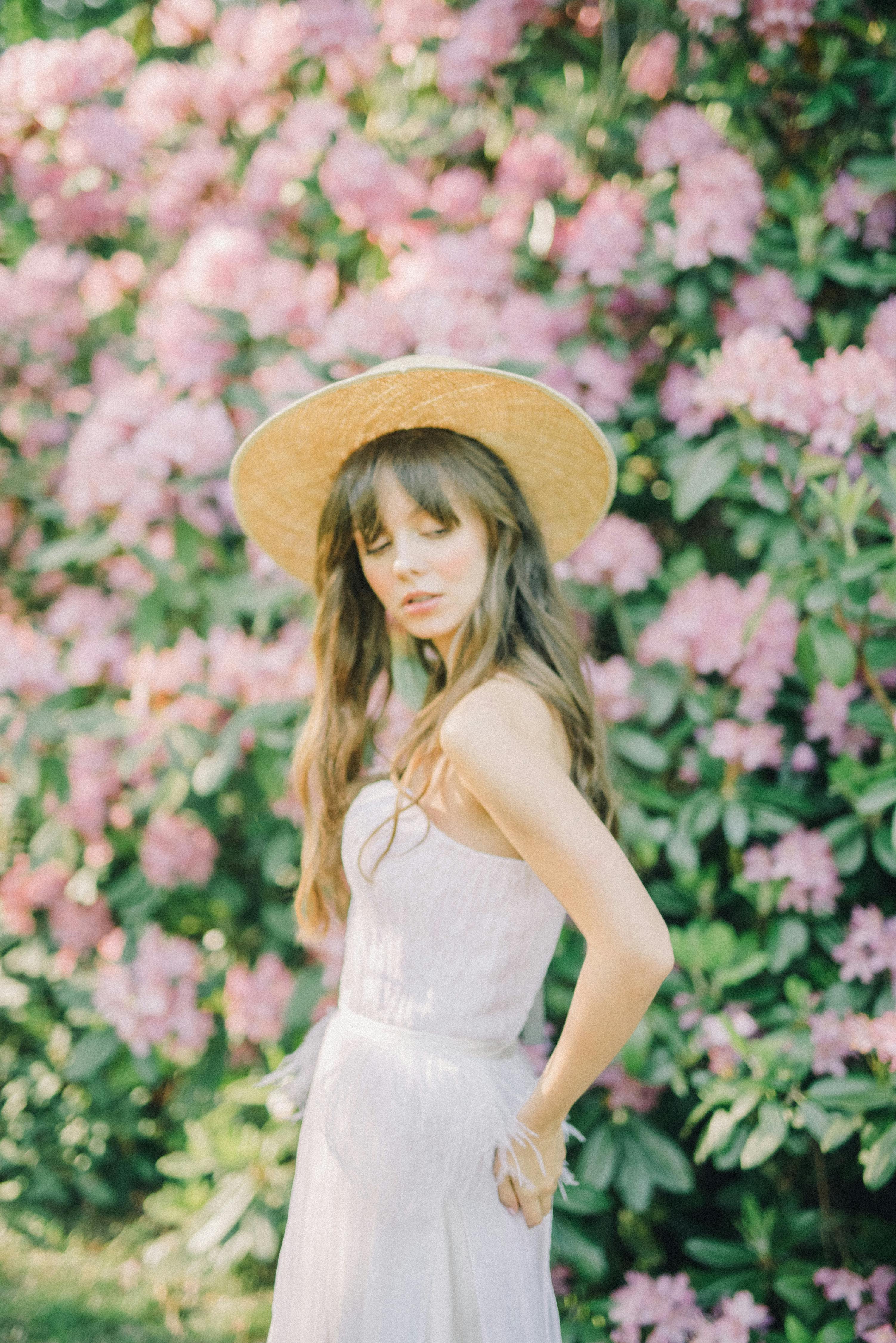 A Female Model Holding a Bunch of Pink Flowers · Free Stock Photo