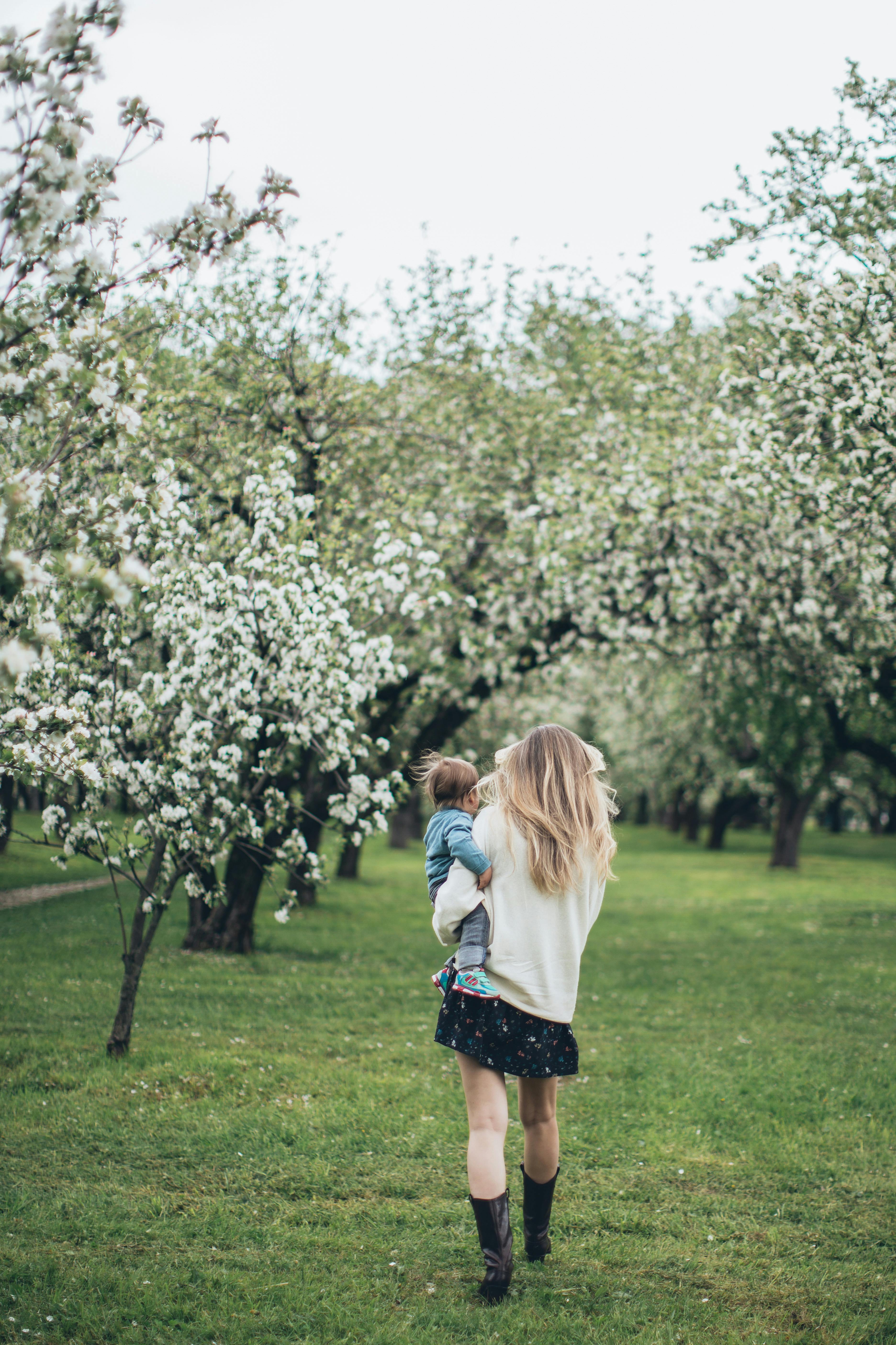 A Woman Carrying a Child · Free Stock Photo