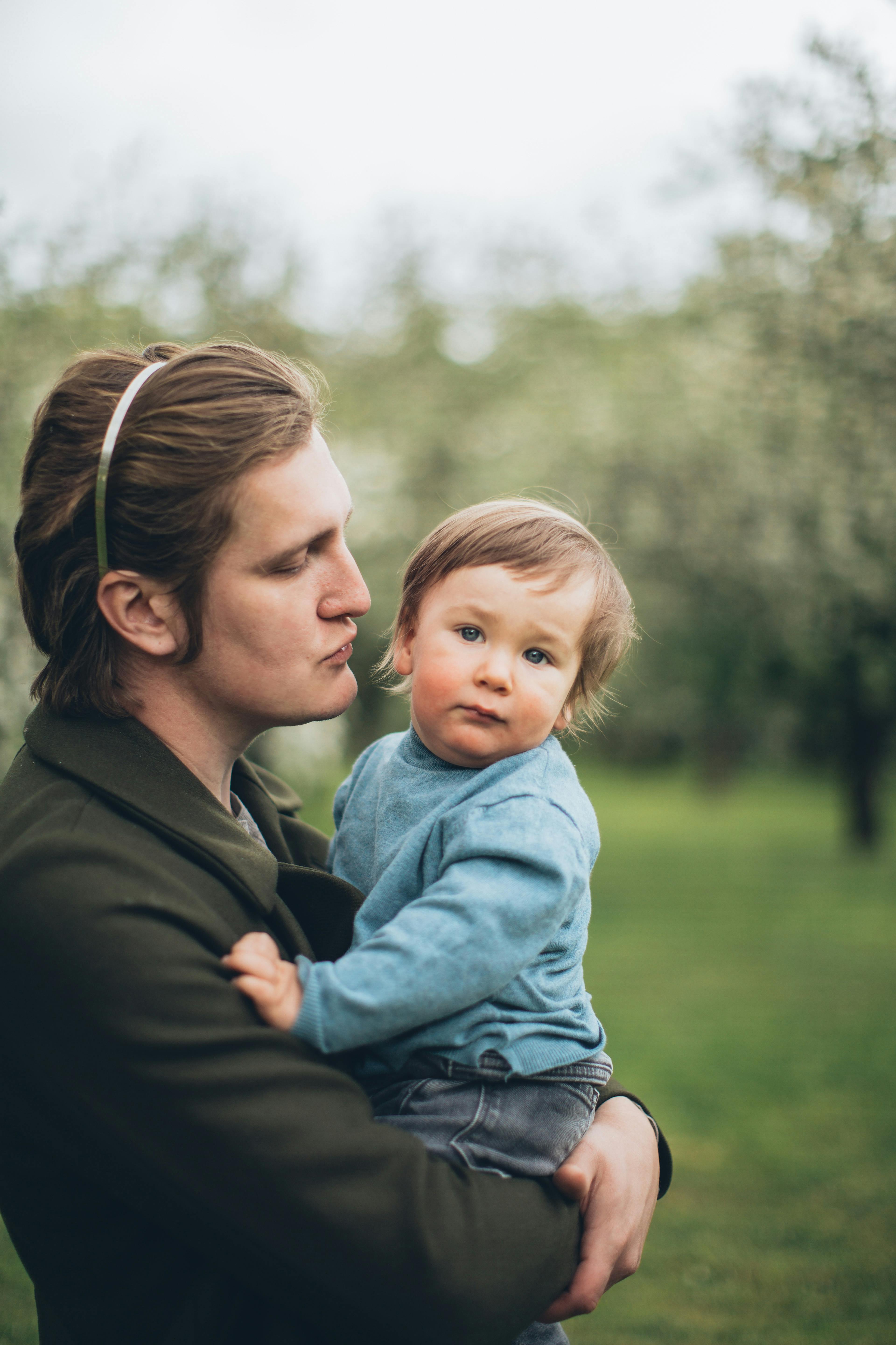 A Man Carrying a Child · Free Stock Photo