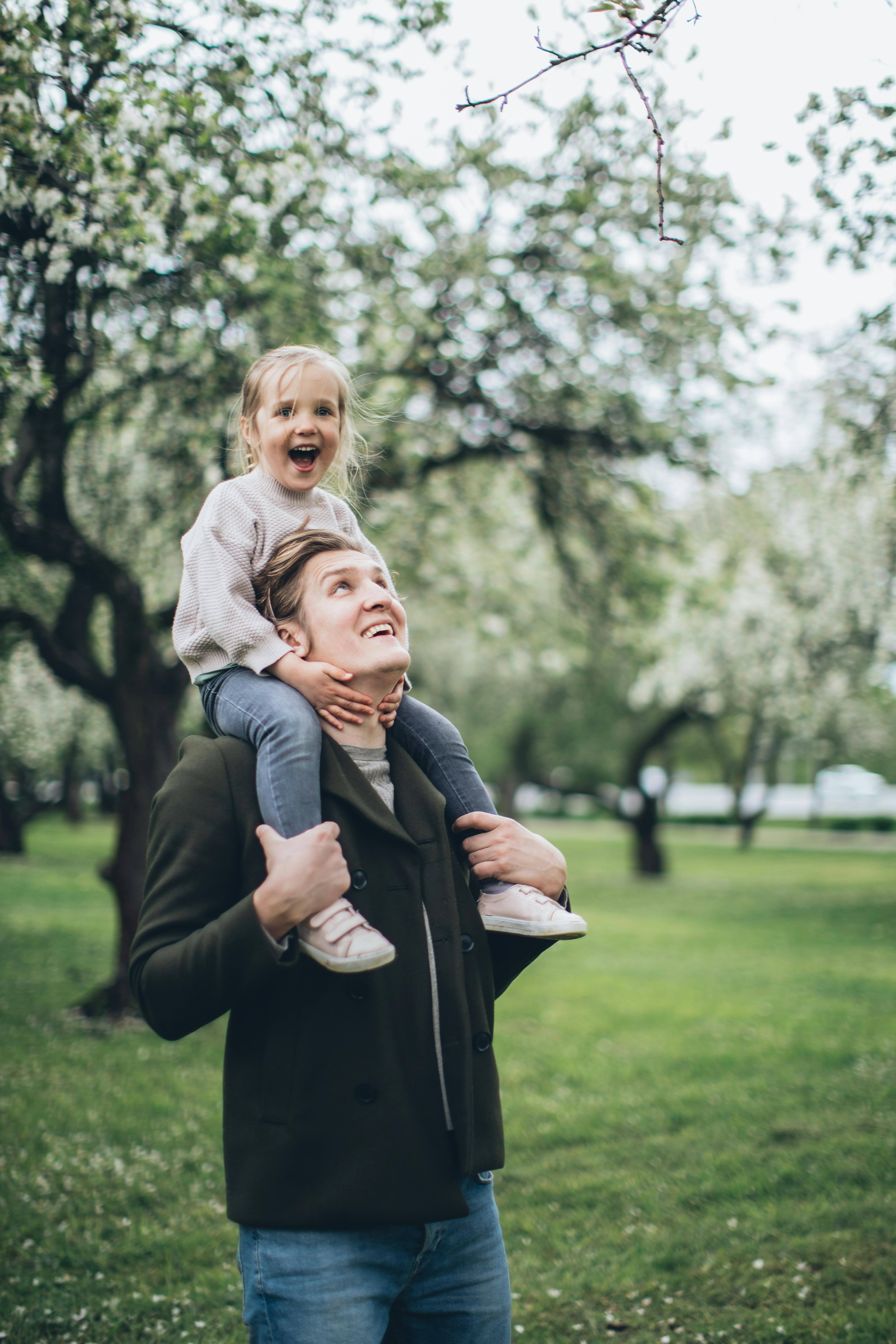 Father giving piggyback ride to daughter · Free Stock Photo