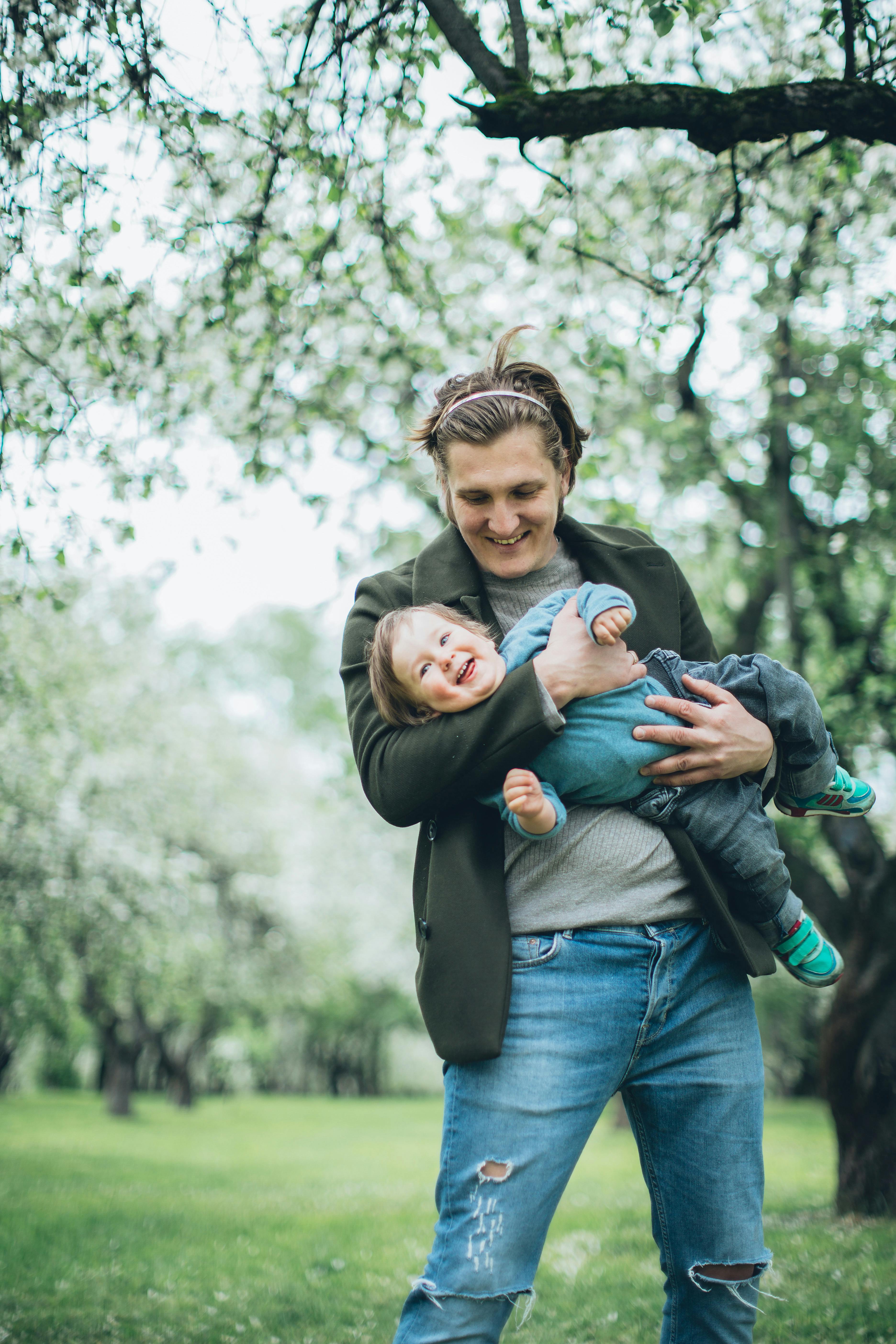 A Man Carrying His Child · Free Stock Photo