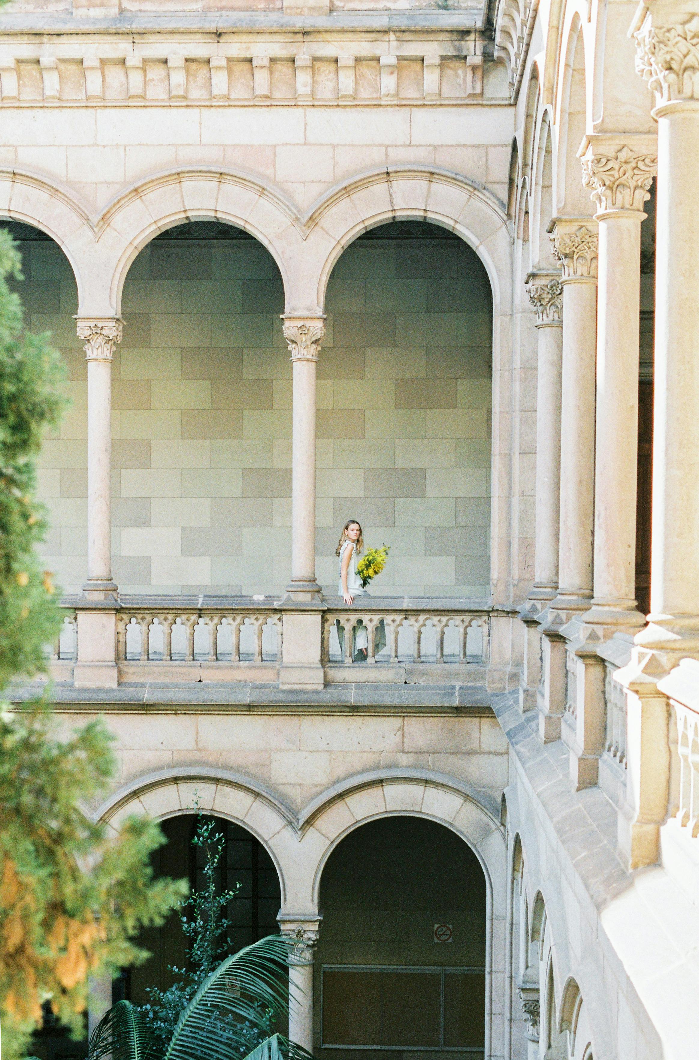 Pretty Women Standing Between Concrete Columns · Free Stock Photo