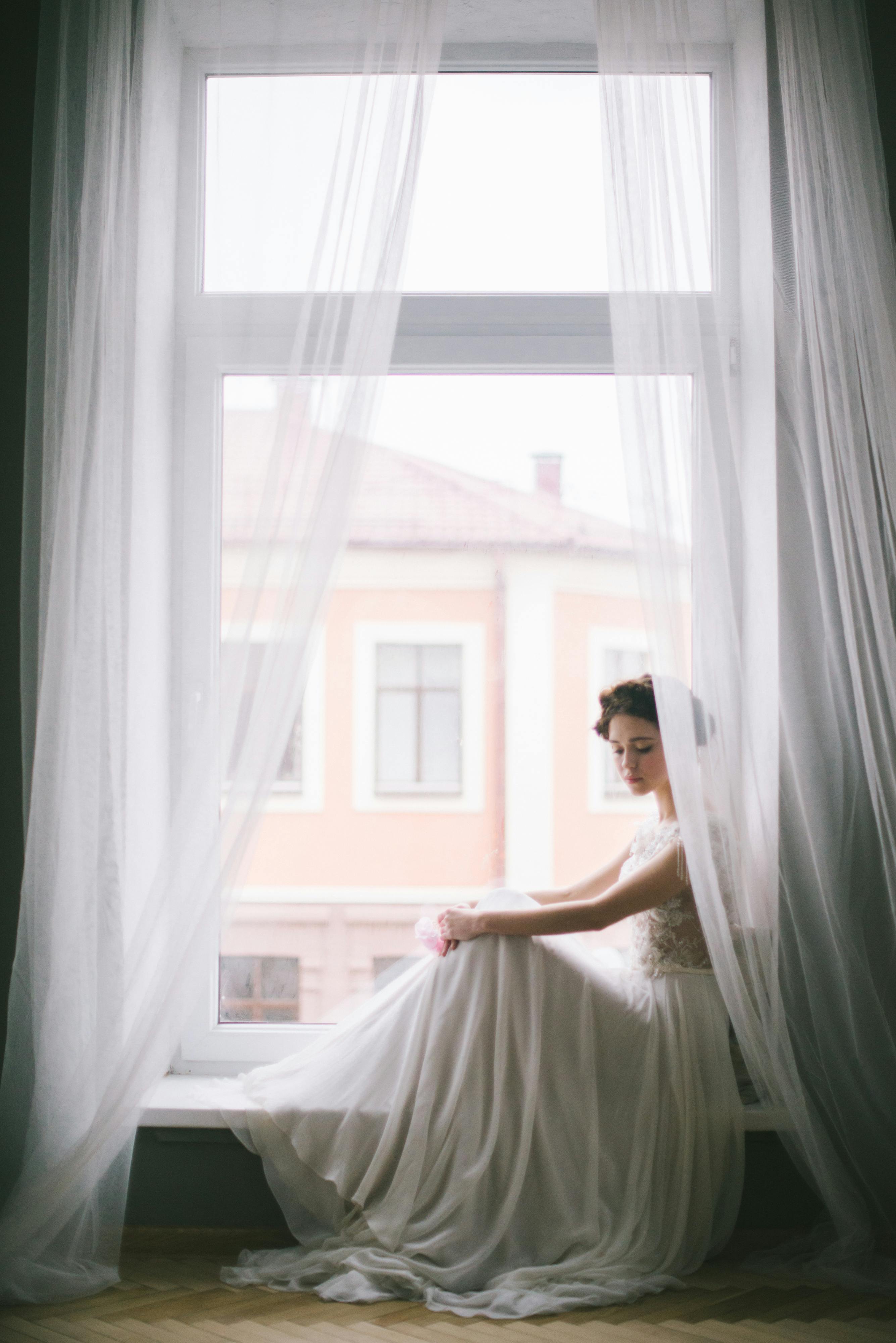 Woman Standing Behind A Red Sheer Curtain Fabric · Free Stock Photo