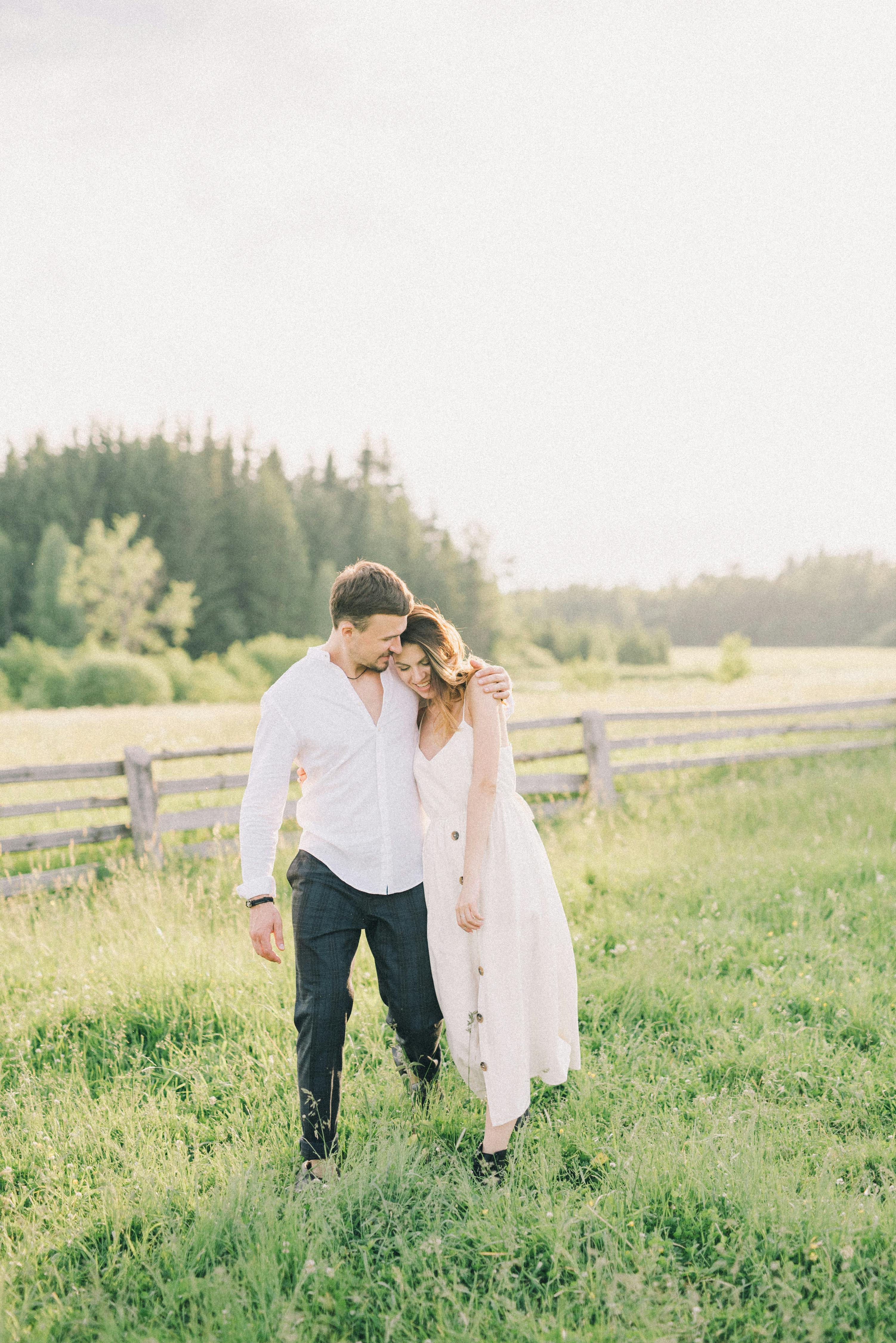 Happy Couple Walking on a Field · Free Stock Photo