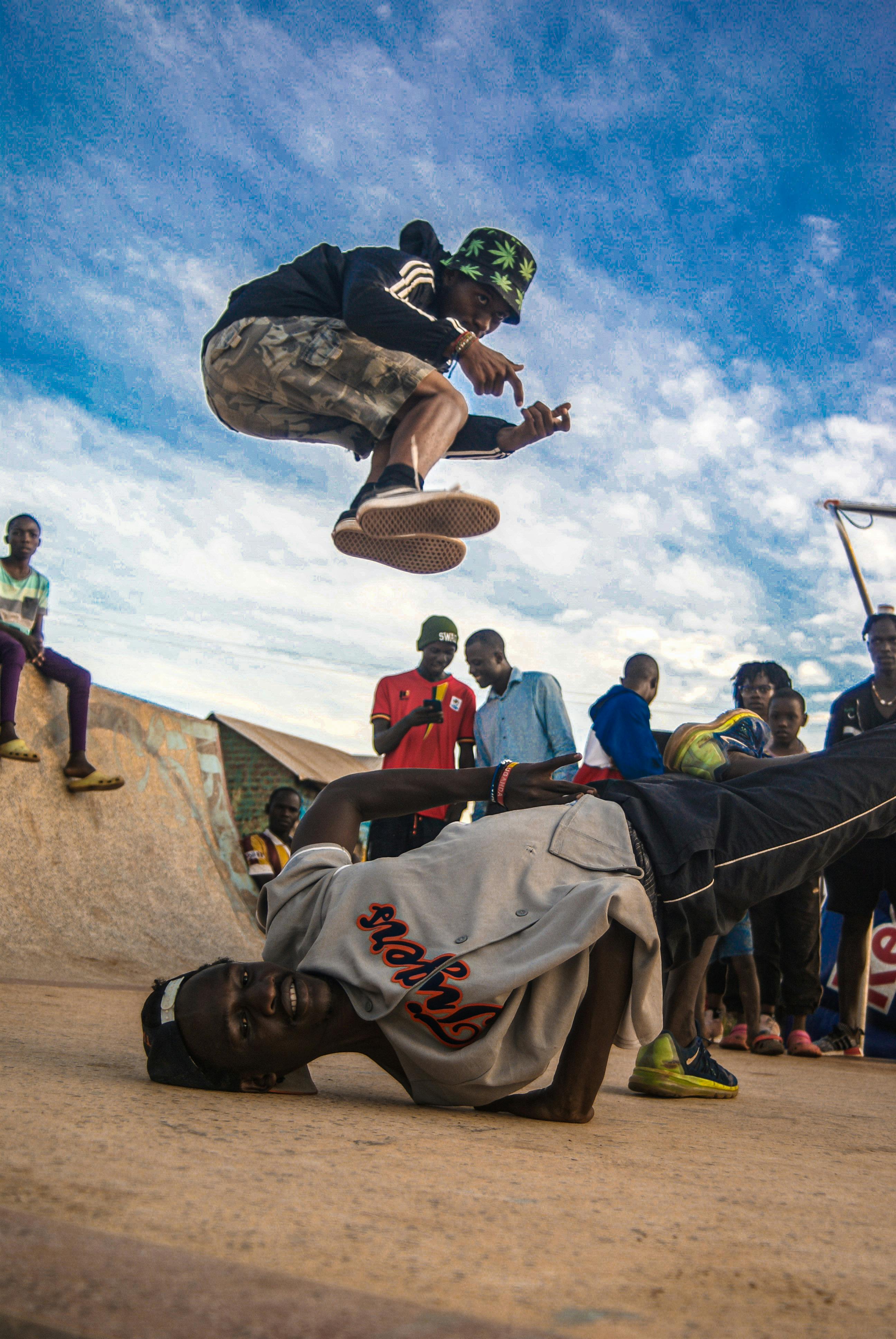 Black men dancing breakdance around people · Free Stock Photo