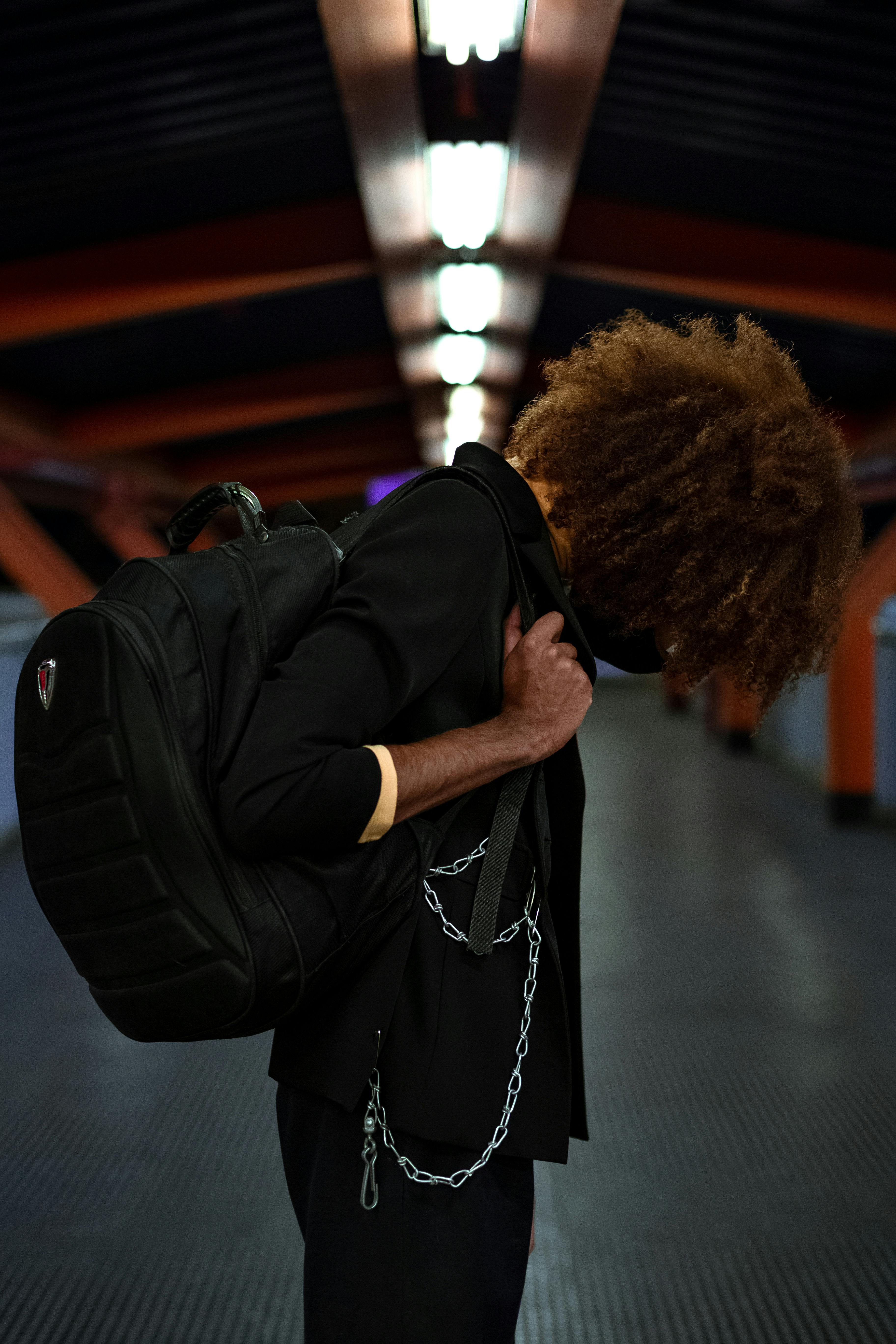 Black man with backpack standing in underground · Free Stock Photo