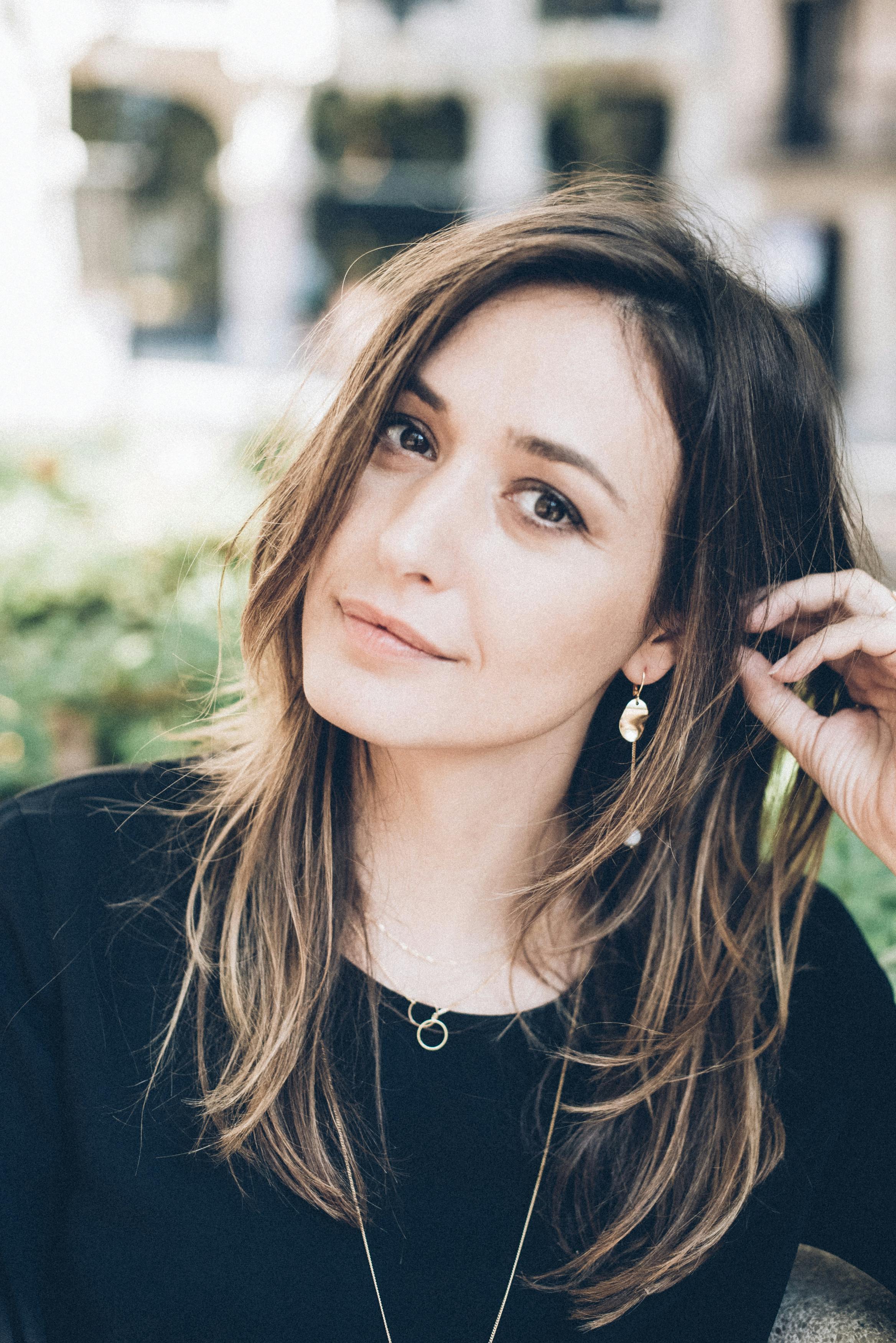 A Portrait of a Pretty Woman Wearing Gold Accessories · Free Stock Photo