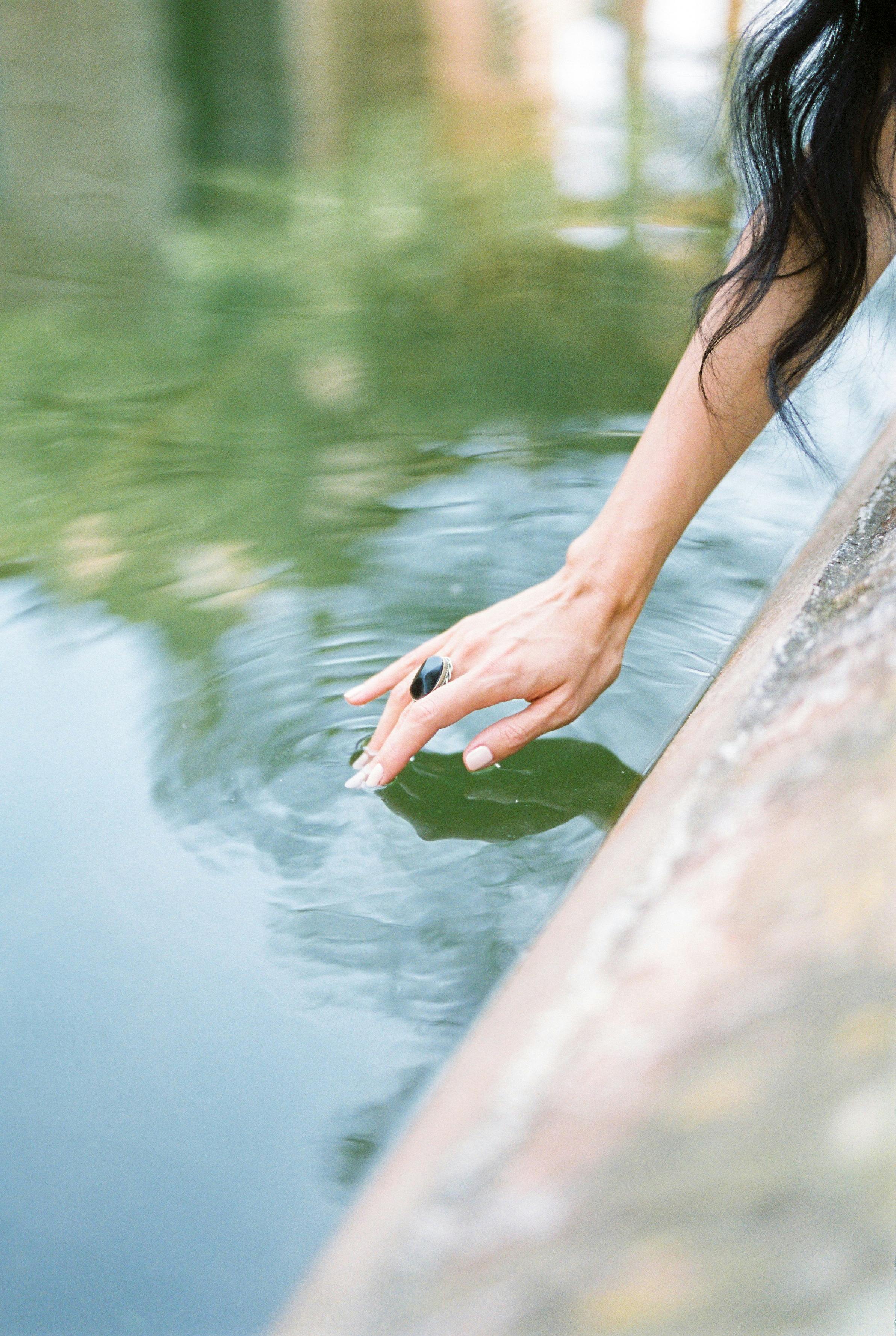 Female Hand Touching the Surface of Water · Free Stock Photo