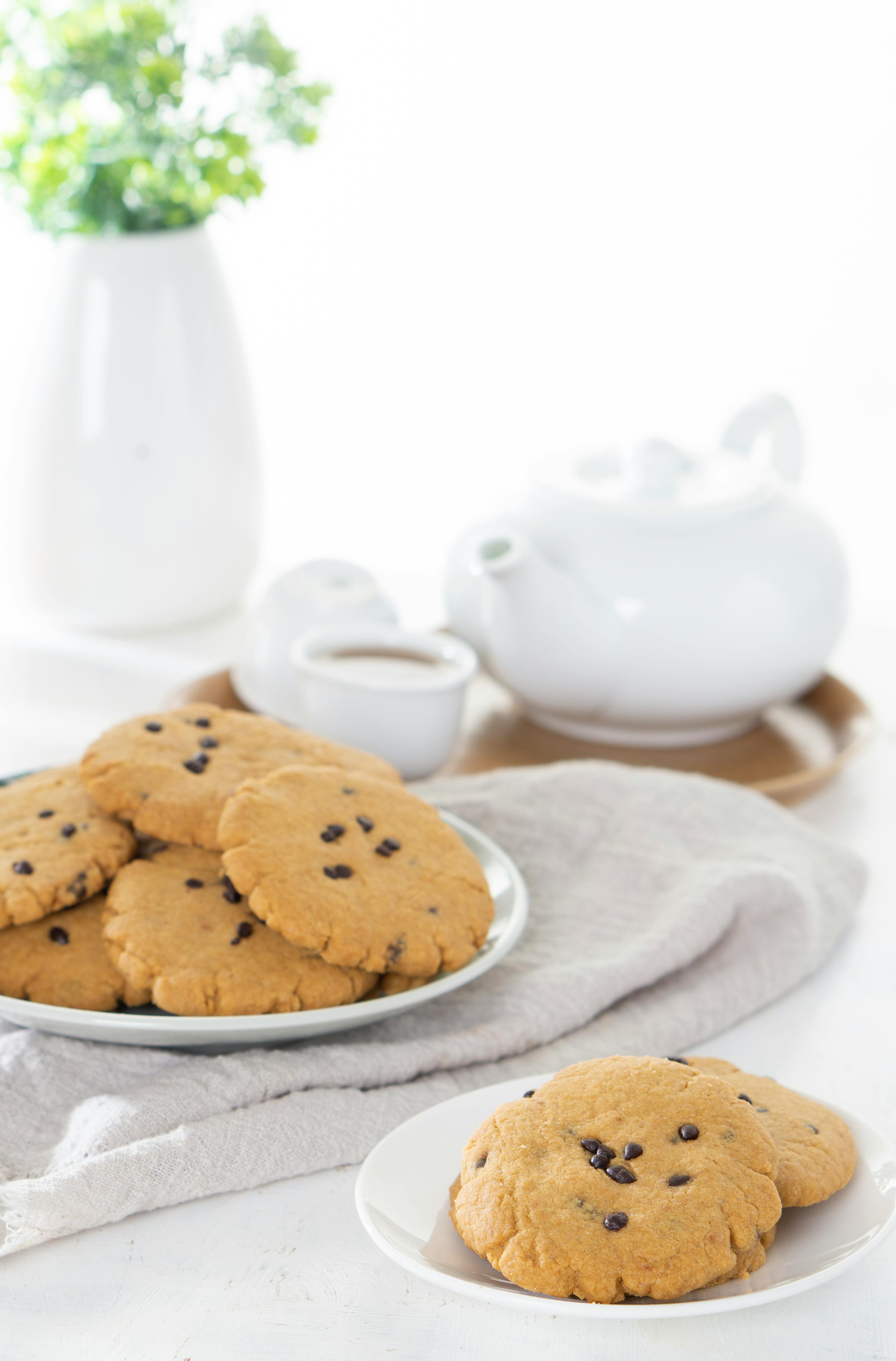 Baked Cookies on Plate Beside Teapot · Free Stock Photo