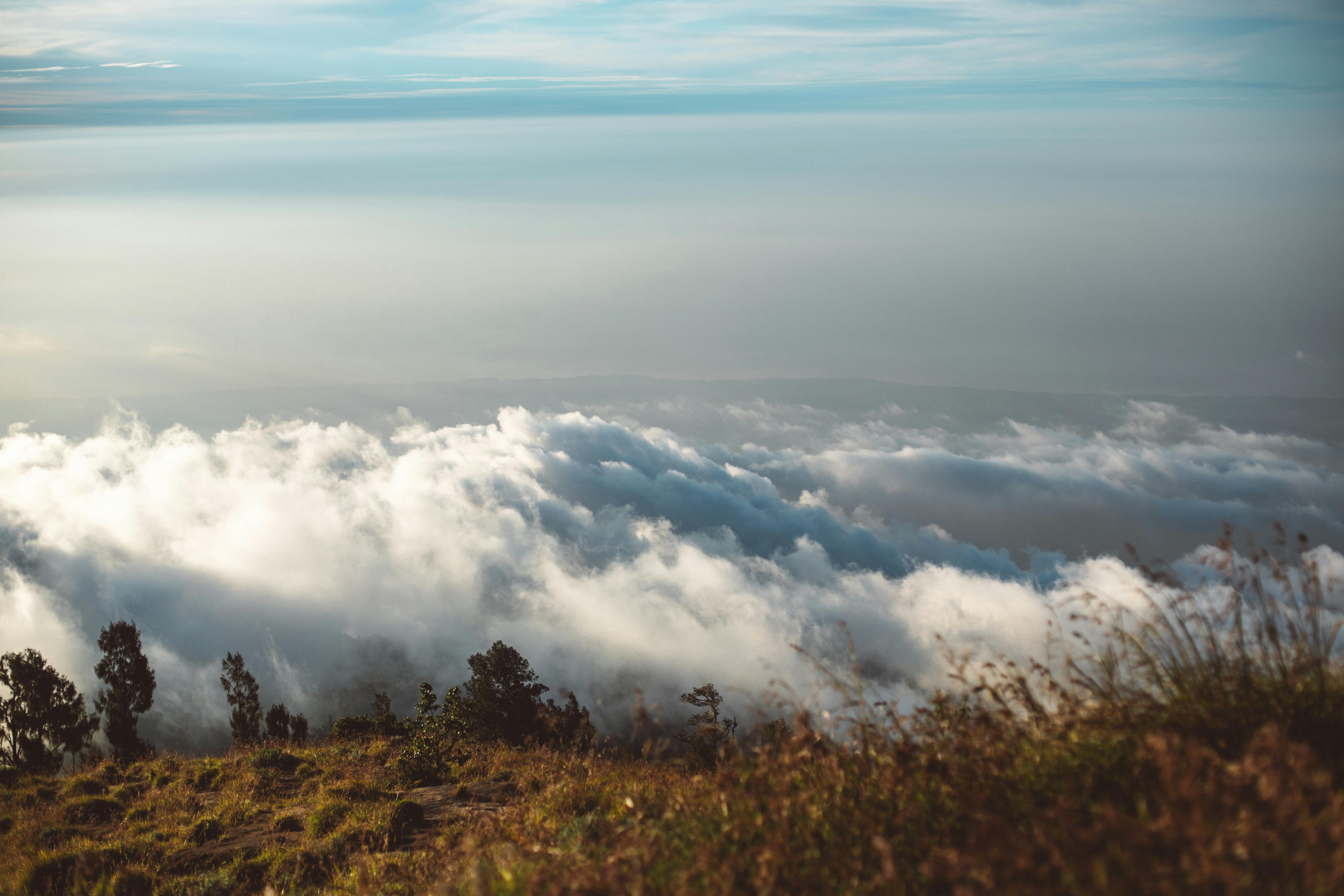 Clouds hanging over terrain in overcast weather · Free Stock Photo