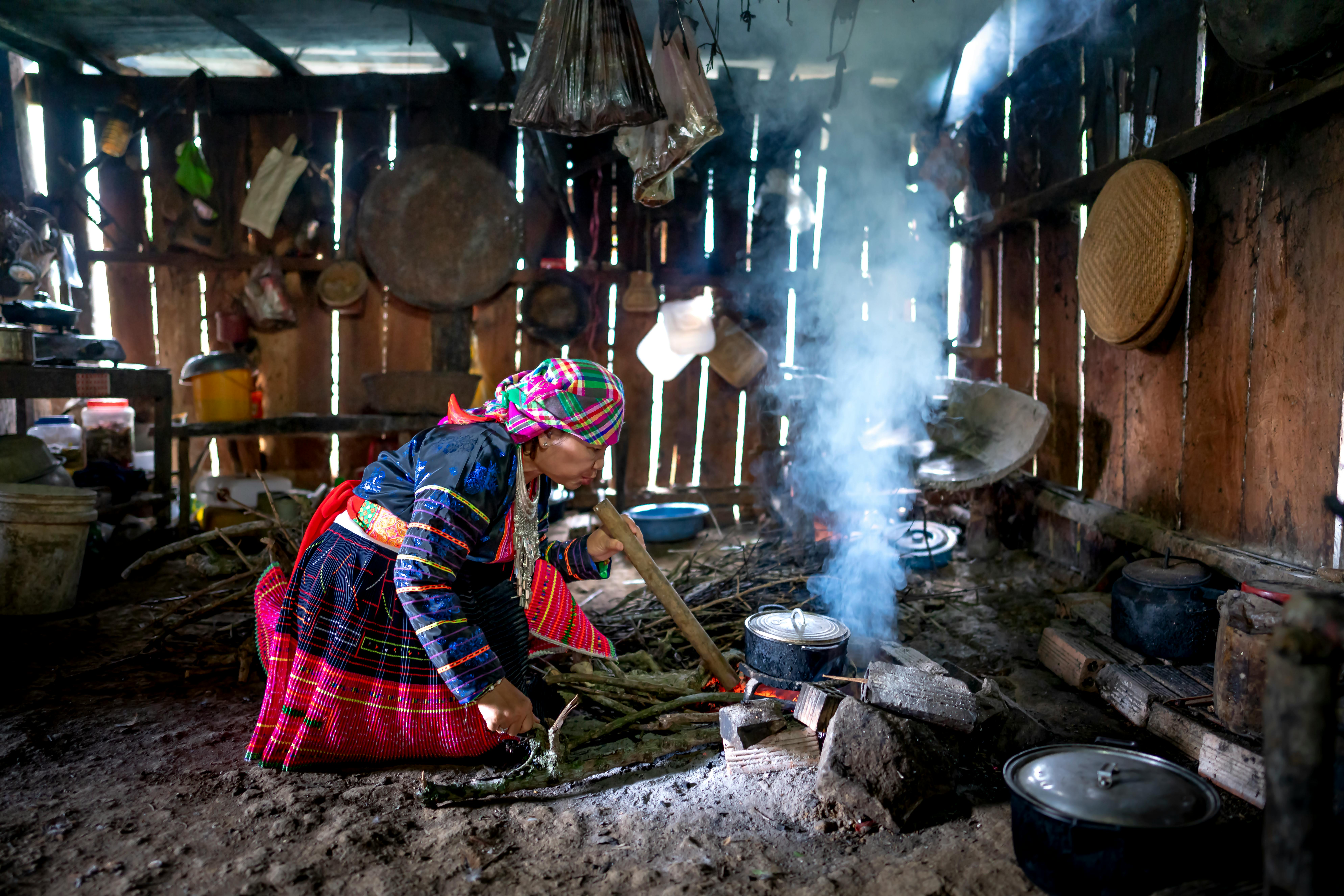 Focused woman cooking on fire · Free Stock Photo