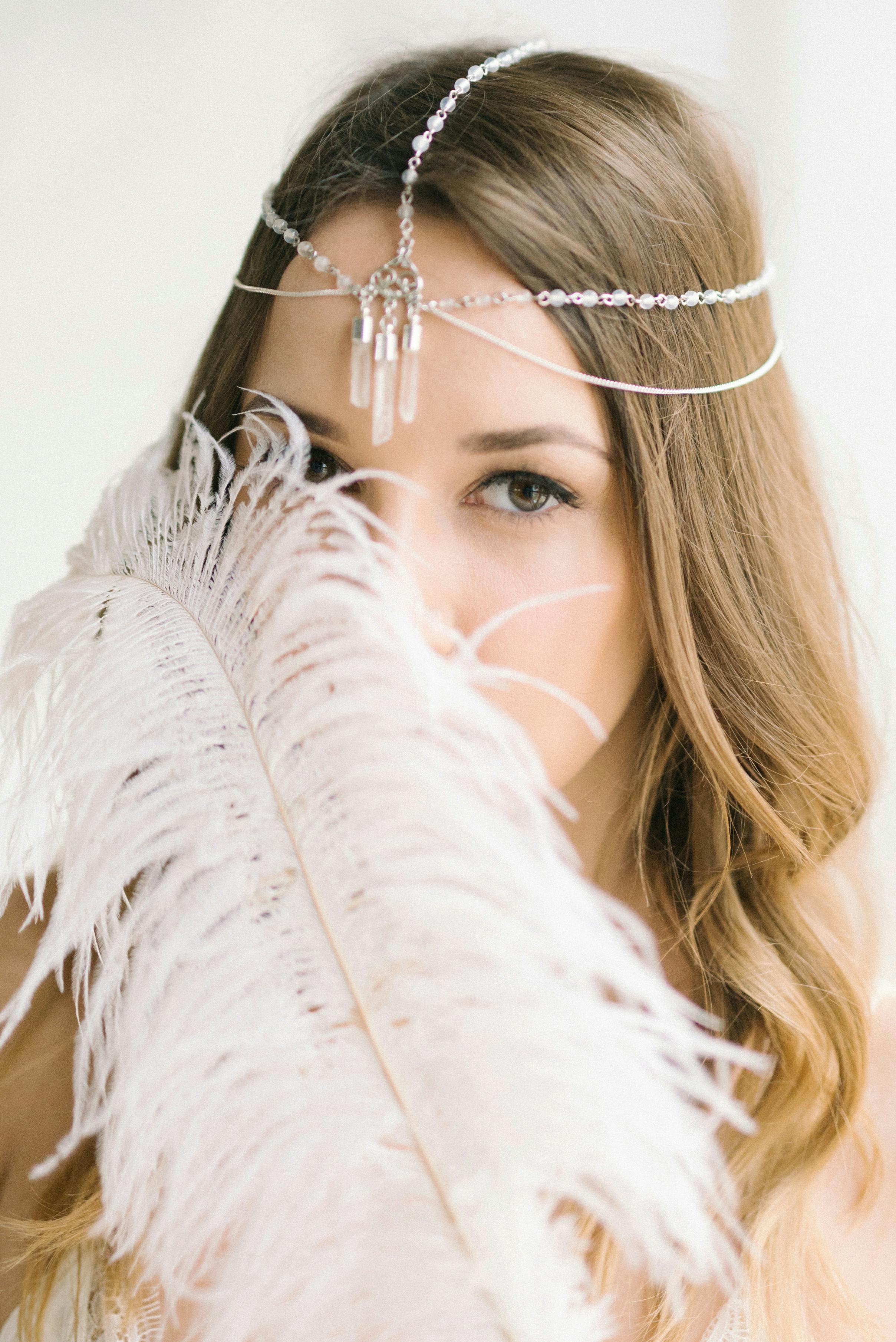 White Feather near Woman's Face · Free Stock Photo
