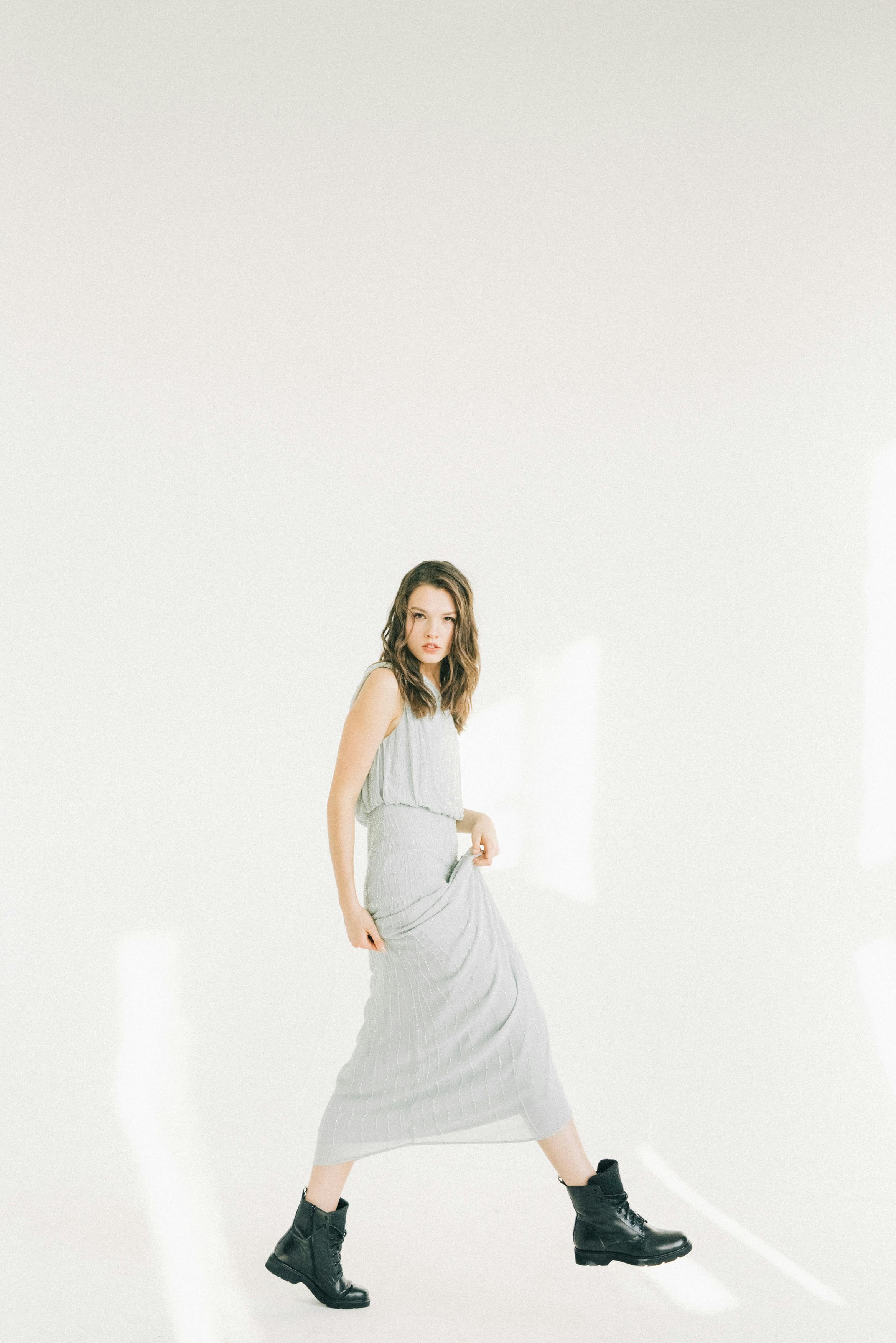 Woman in a Gray Dress in a Grassland · Free Stock Photo