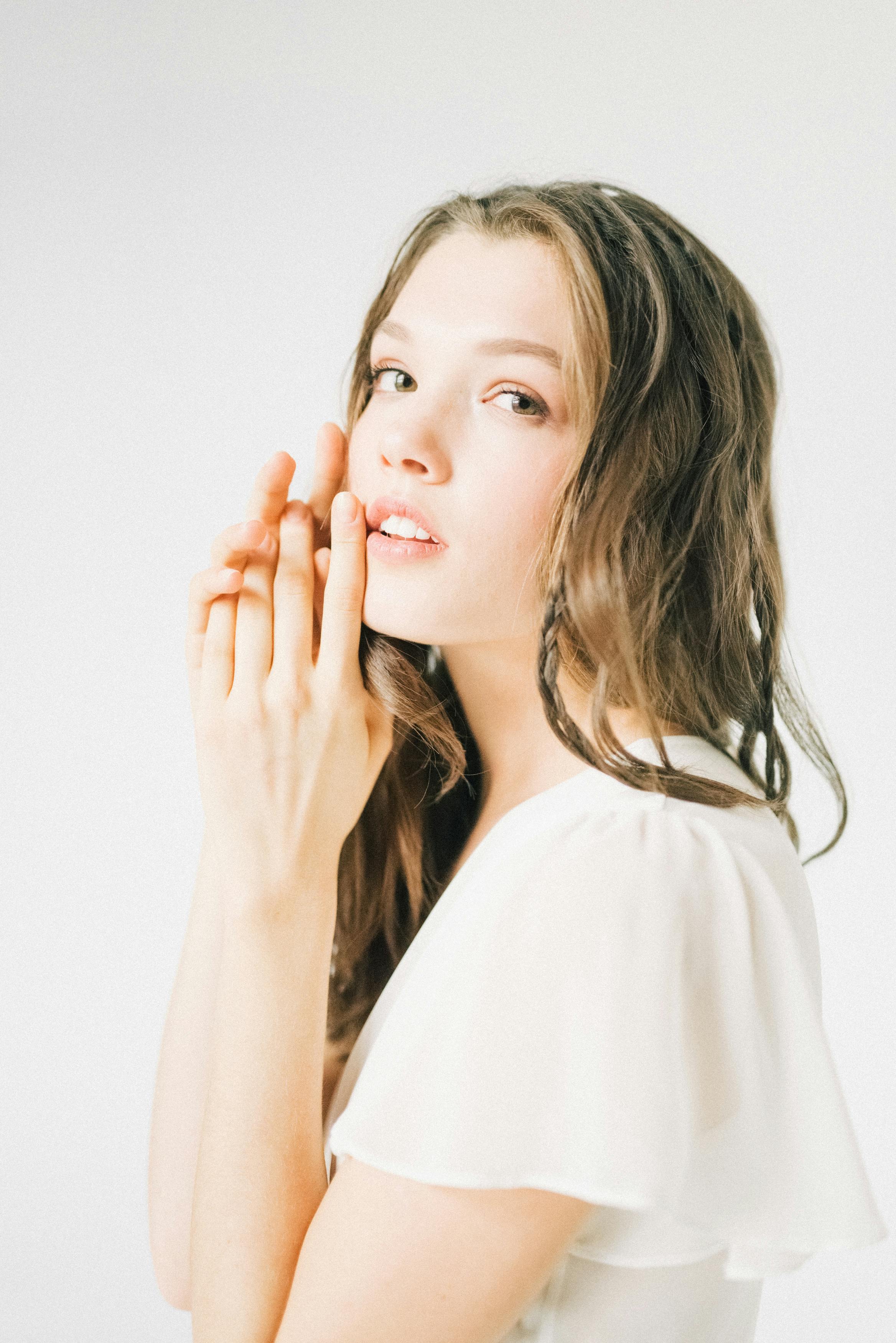 A Beautiful Woman with Her Hands on Her Face · Free Stock Photo