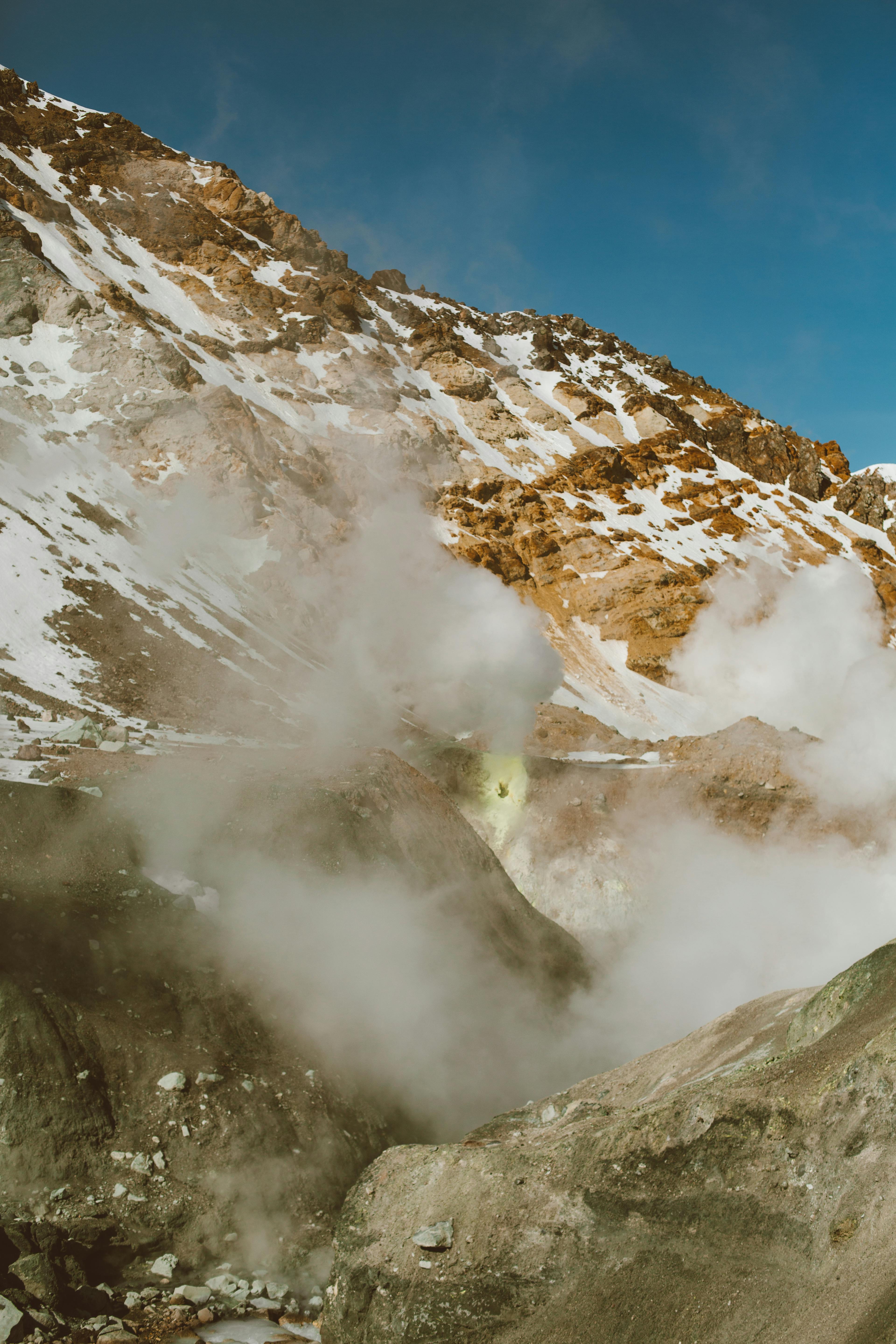Blowing steam off from volcano in highlands in sunny day · Free Stock Photo